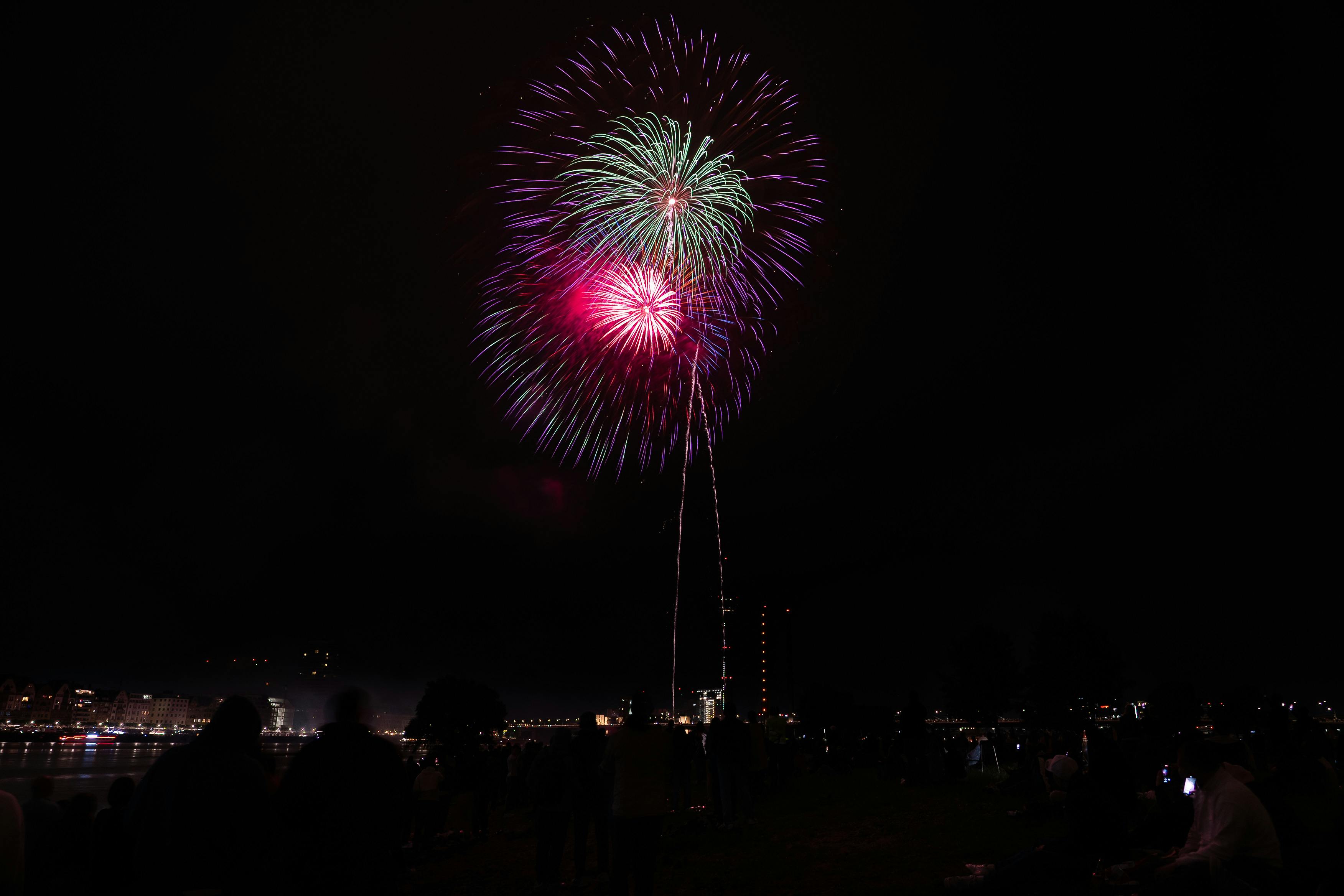 Vibrant Fireworks Display Over Crowded City Skyline · Free Stock Photo