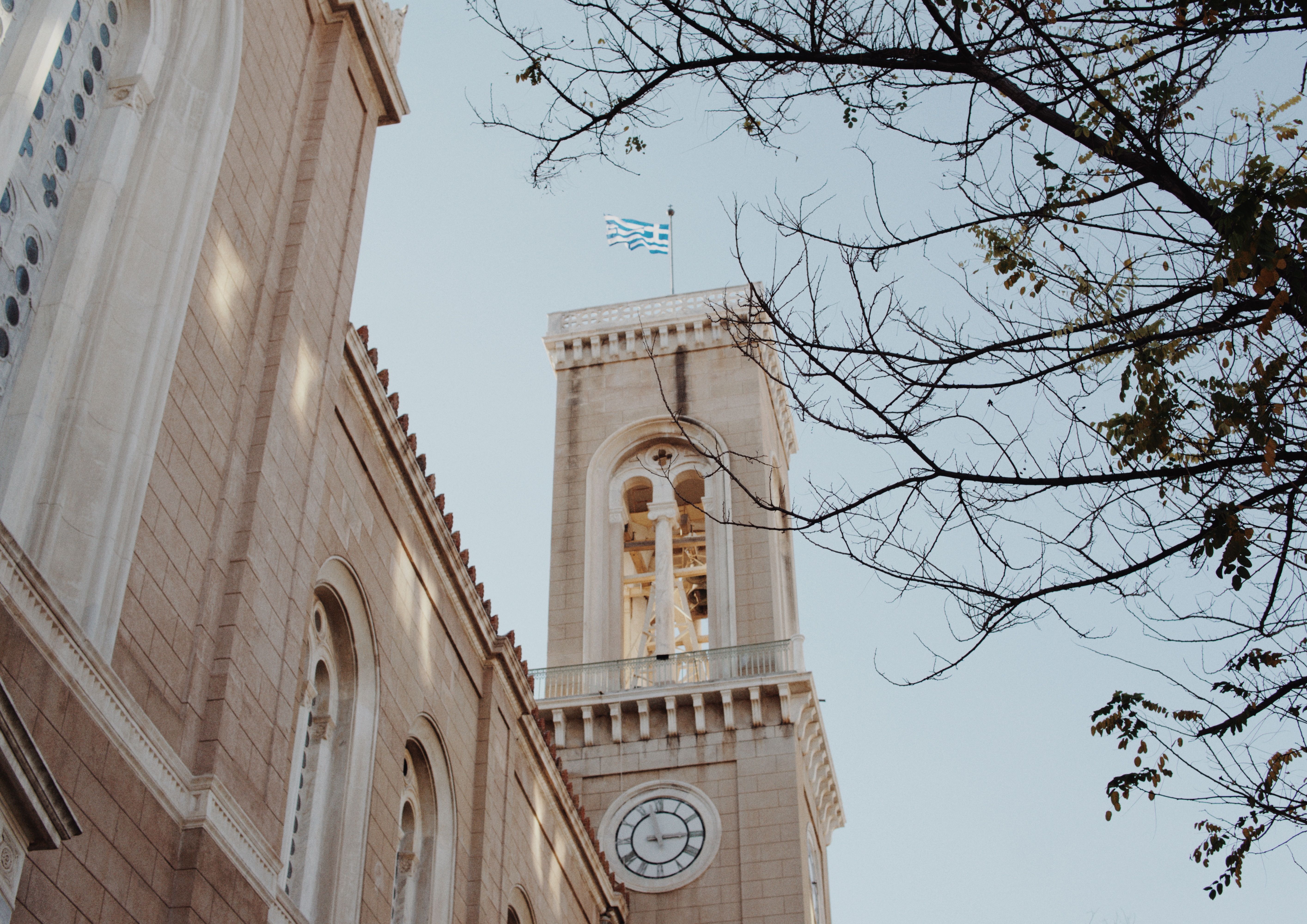 Athens Cathedral Bell Tower with Greek Flag · Free Stock Photo