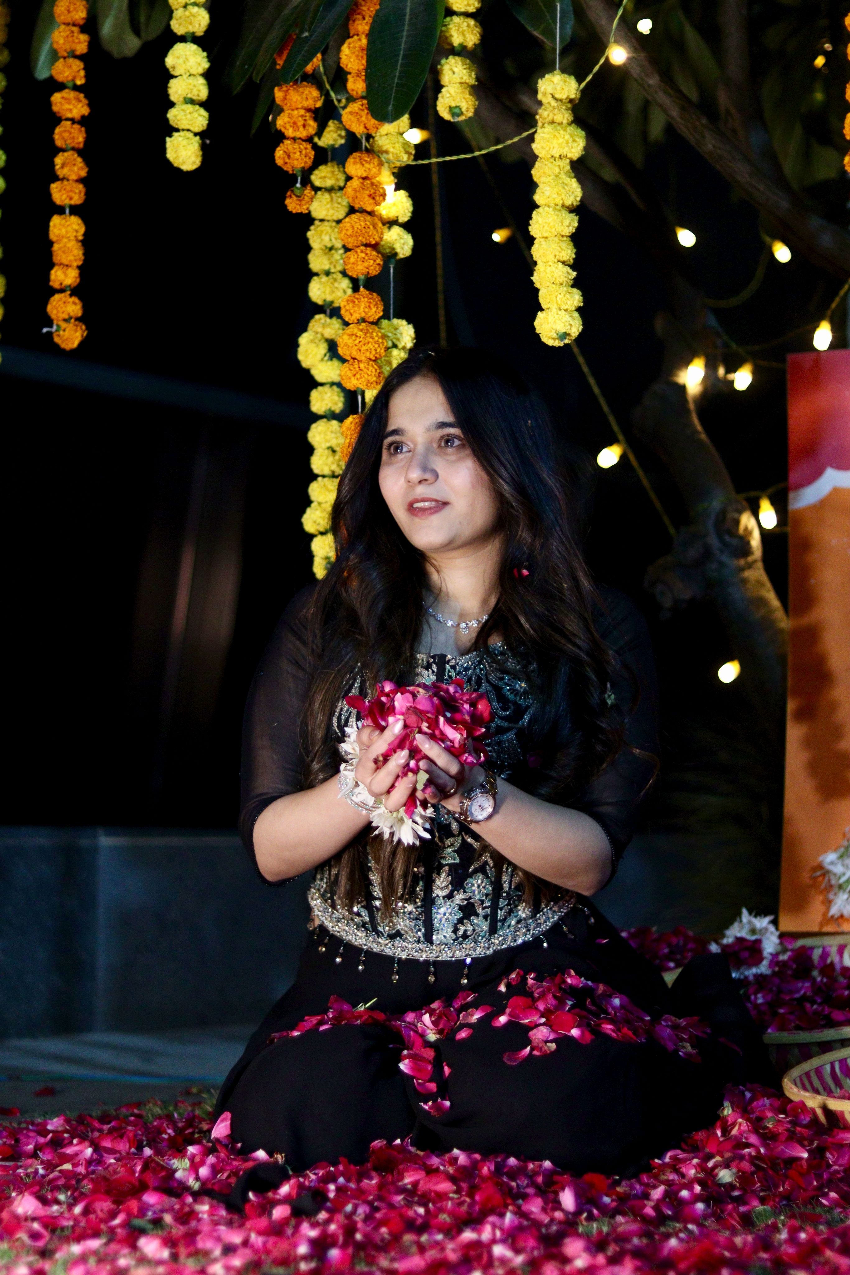 Woman Celebrating with Flower Petals at Night Event · Free Stock Photo