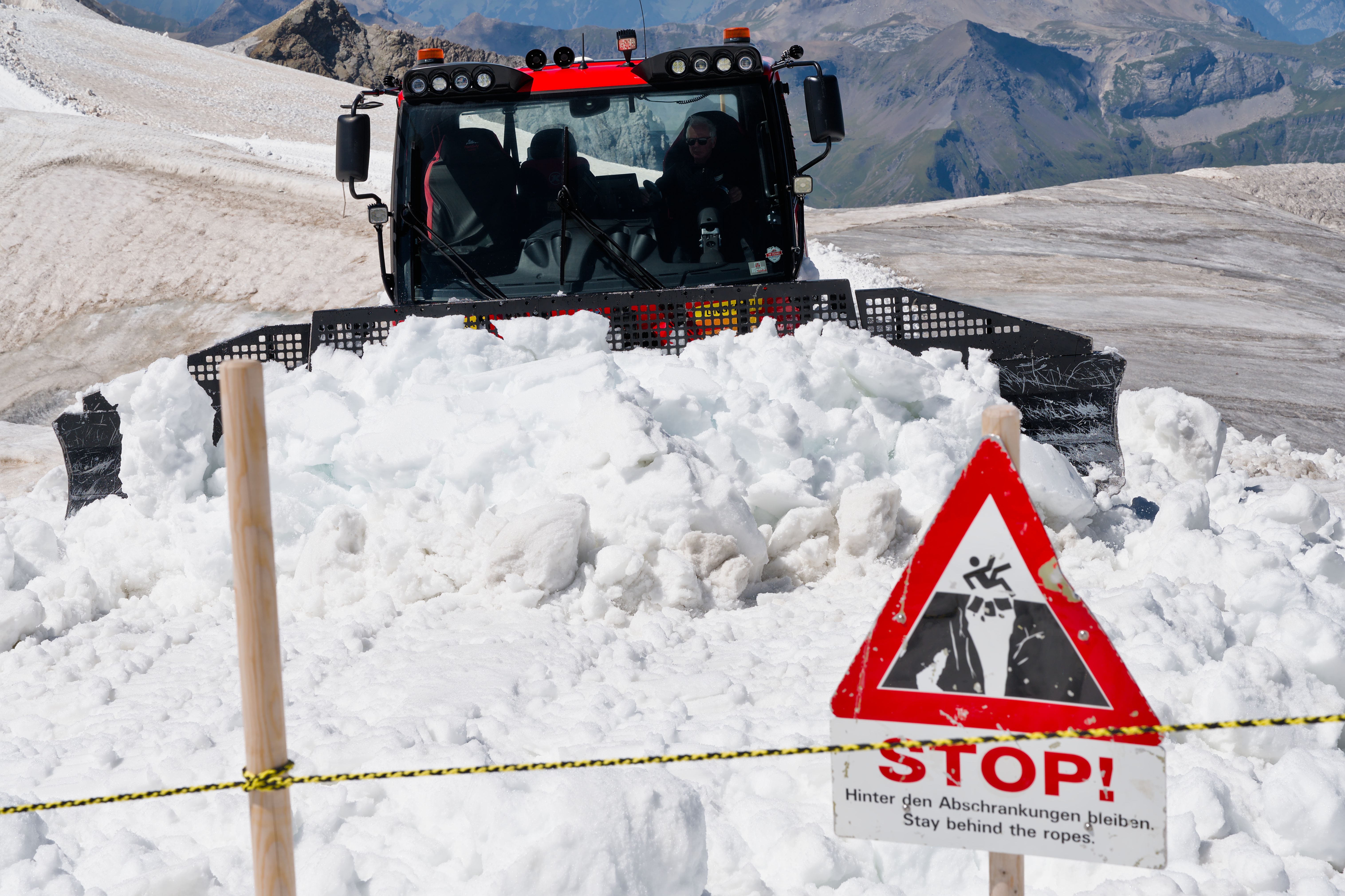 Snowplow Clearing Path on Swiss Mountain · Free Stock Photo