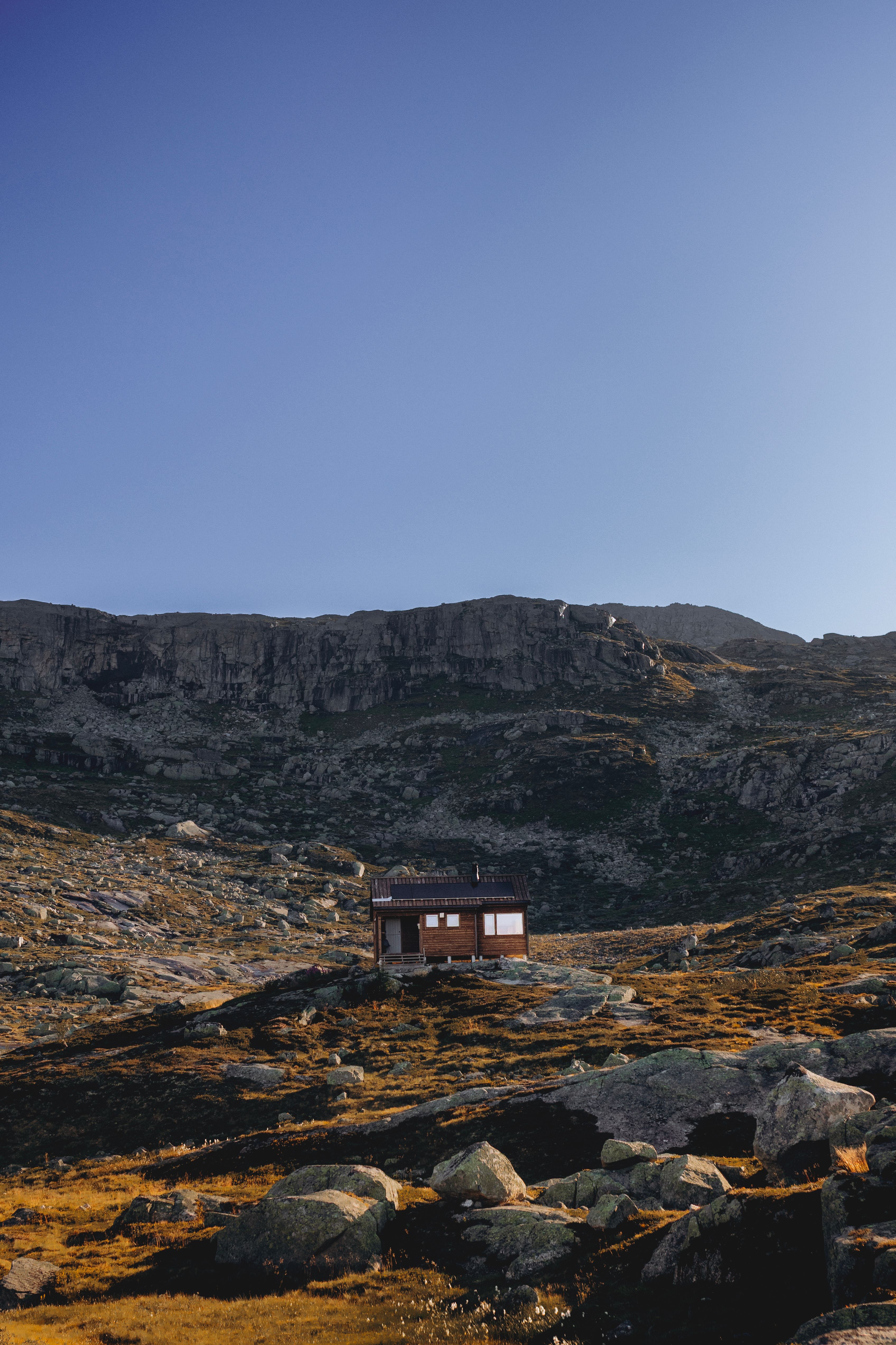 Remote Cabin in Rugged Mountain Landscape · Free Stock Photo