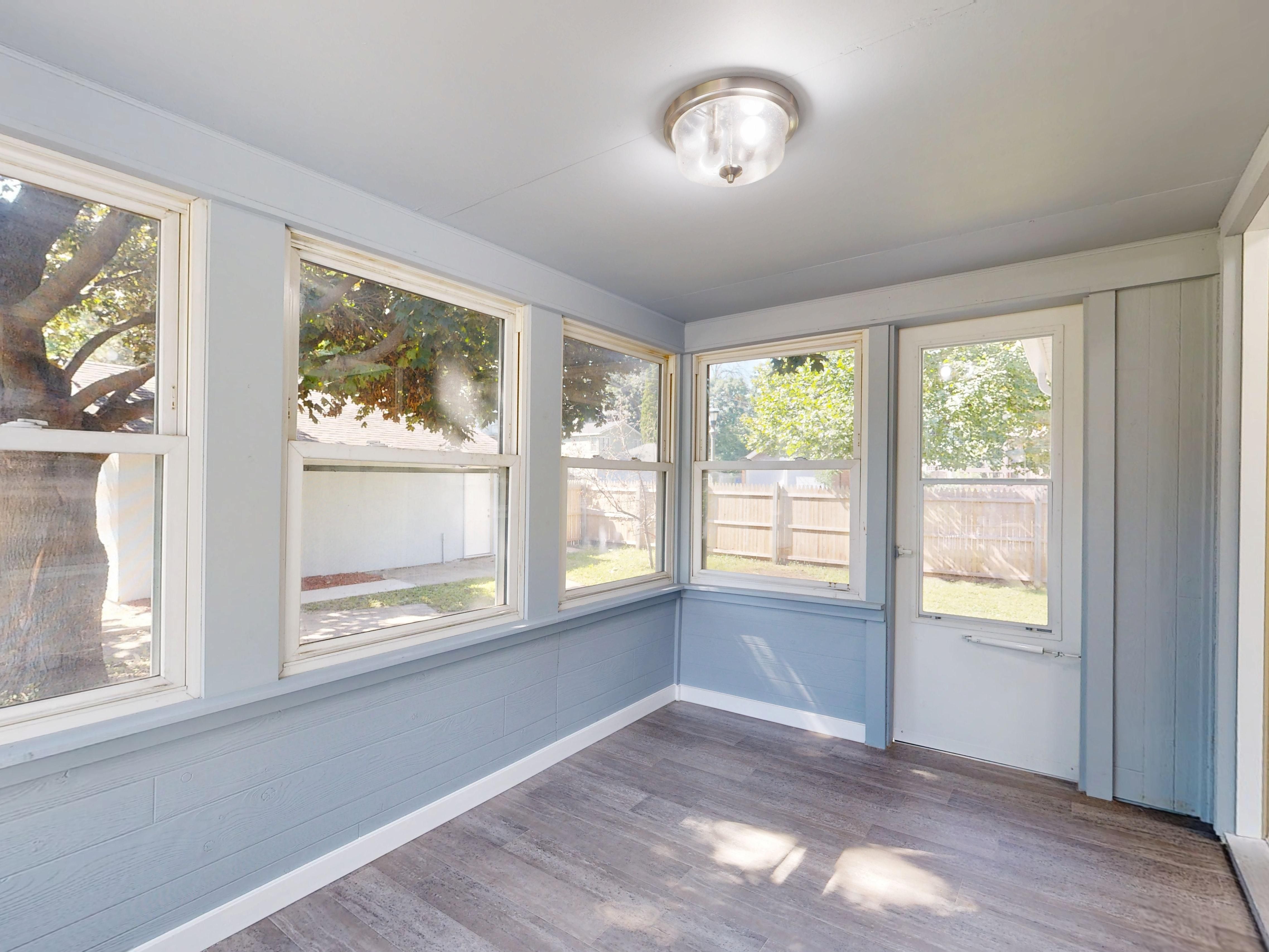 Bright Indoor Sunroom with Large Windows · Free Stock Photo