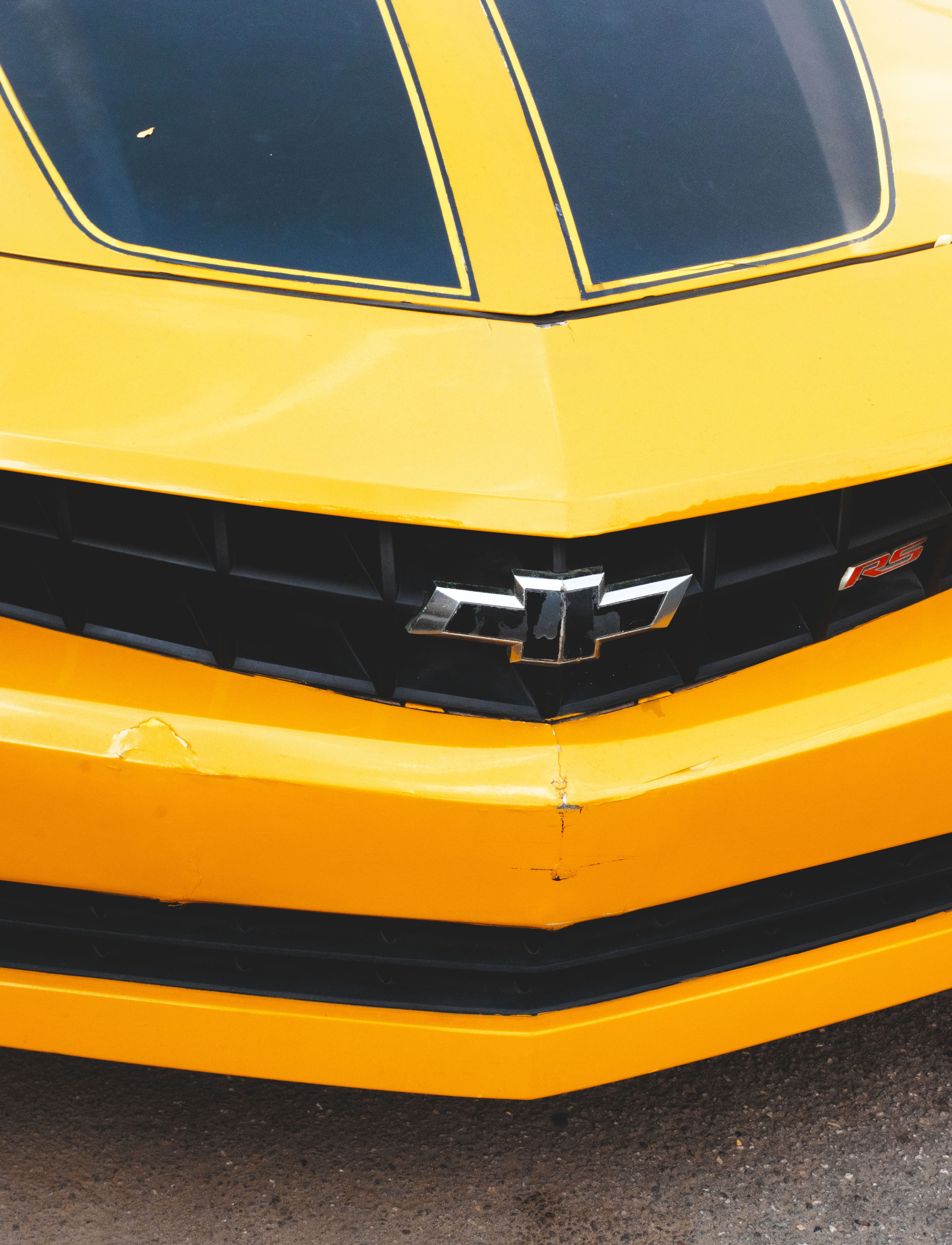 Close-up of Yellow Muscle Car Front with Badge · Free Stock Photo