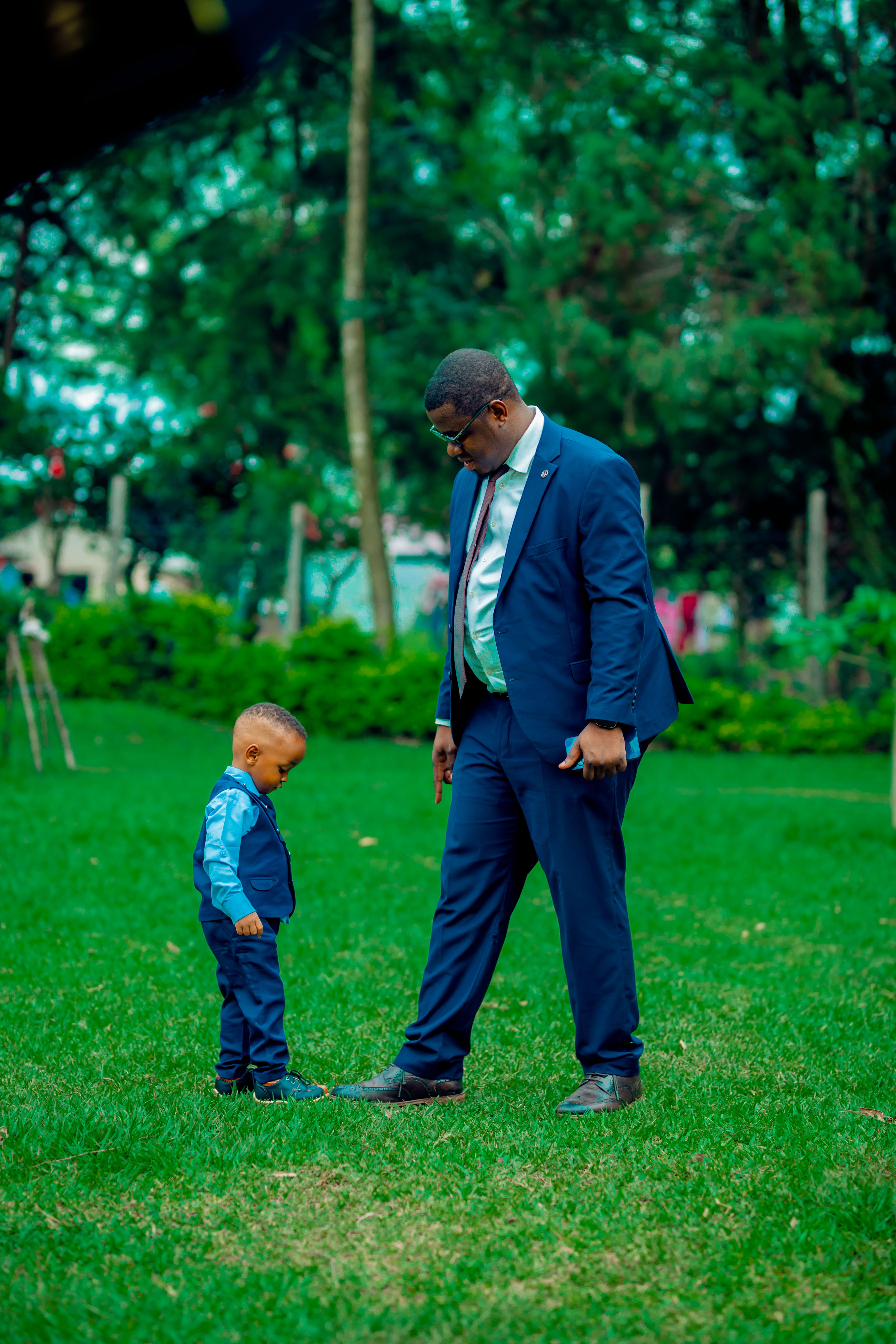 Father and Son in Matching Suits Outdoors · Free Stock Photo
