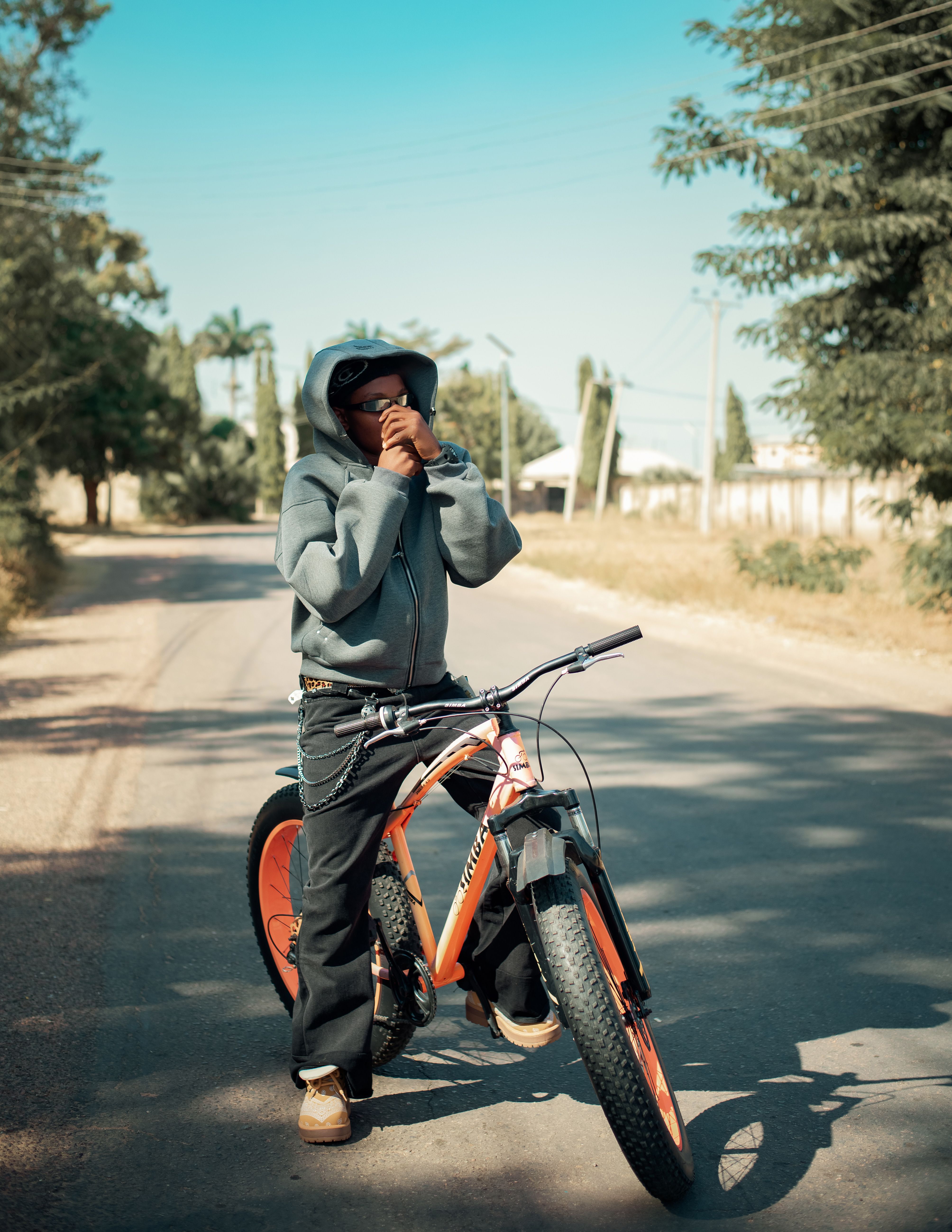 Young Adult on Bicycle in Urban Street Setting · Free Stock Photo
