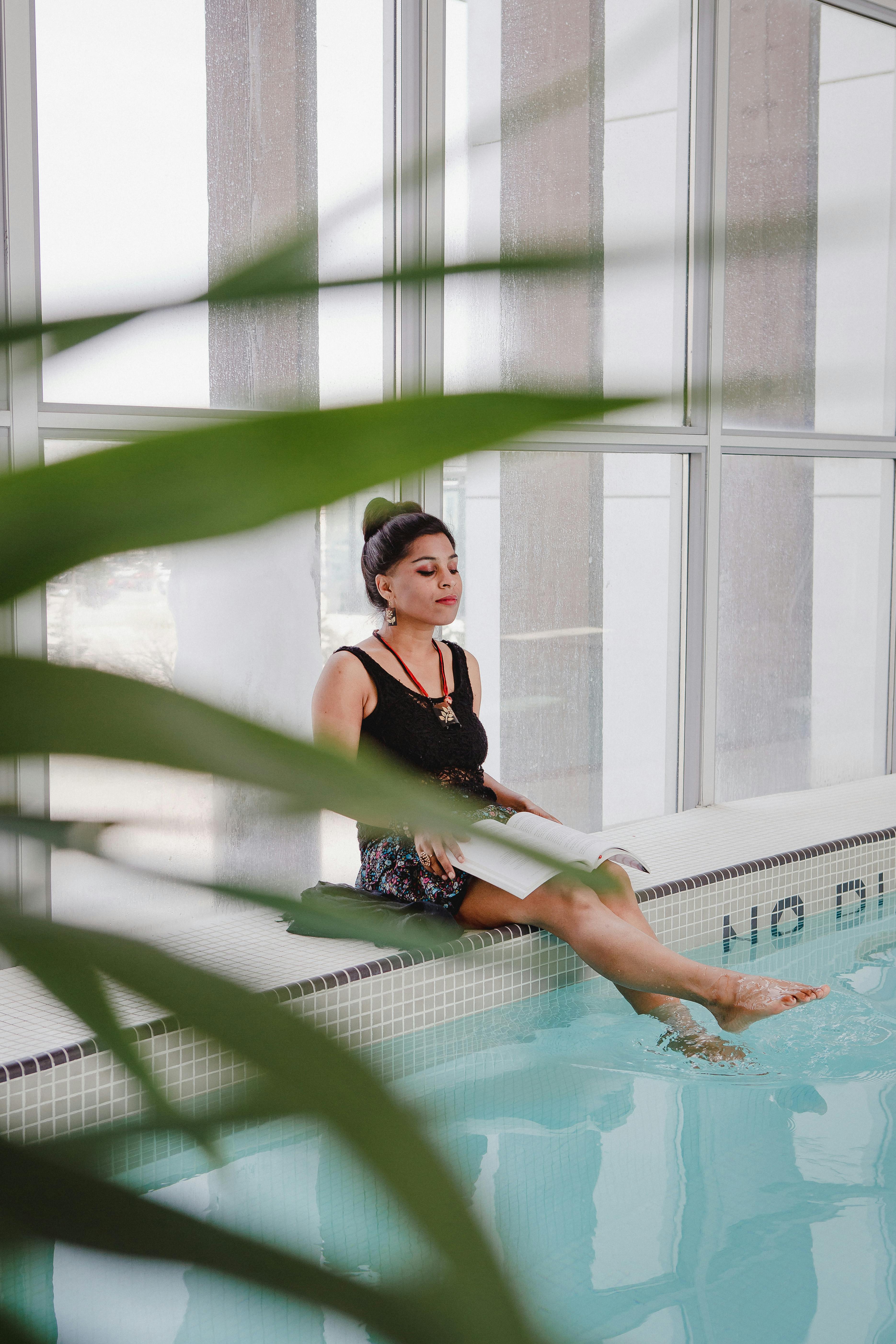 Woman Sitting on Poolside · Free Stock Photo
