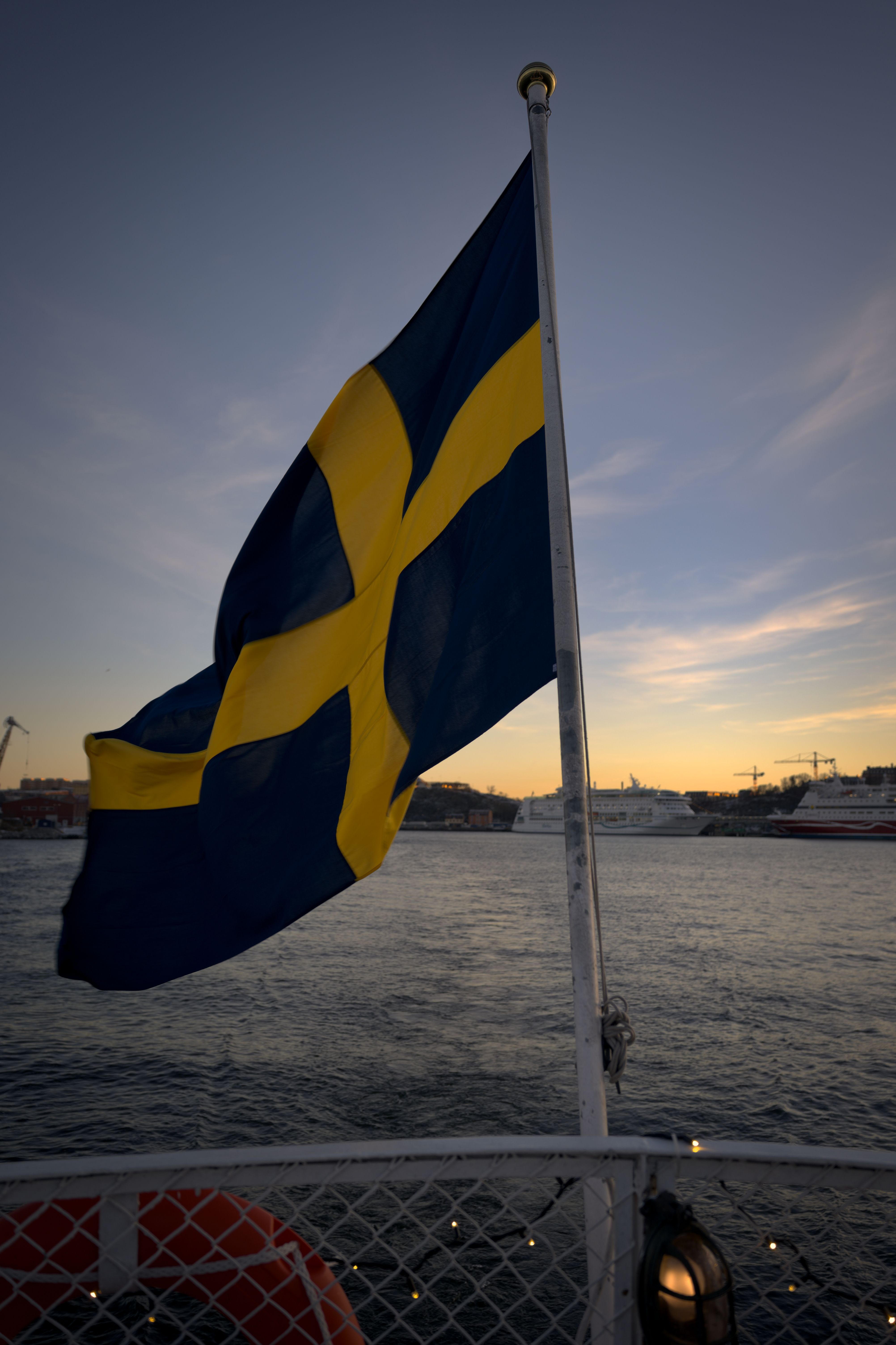 Swedish Flag on a Boat in Stockholm Harbor · Free Stock Photo