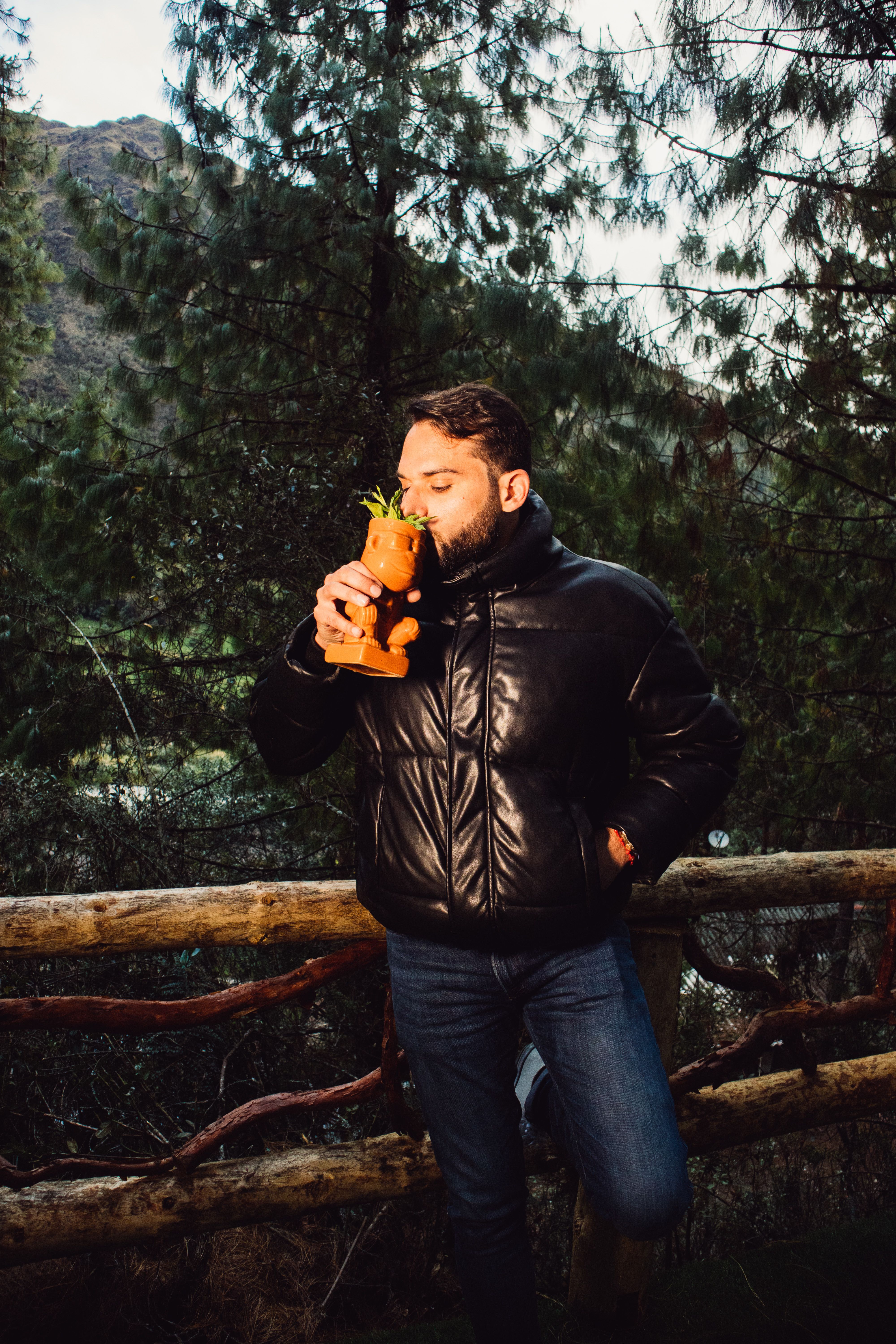 Man Enjoying Outdoor Drink in Scenic Forest · Free Stock Photo