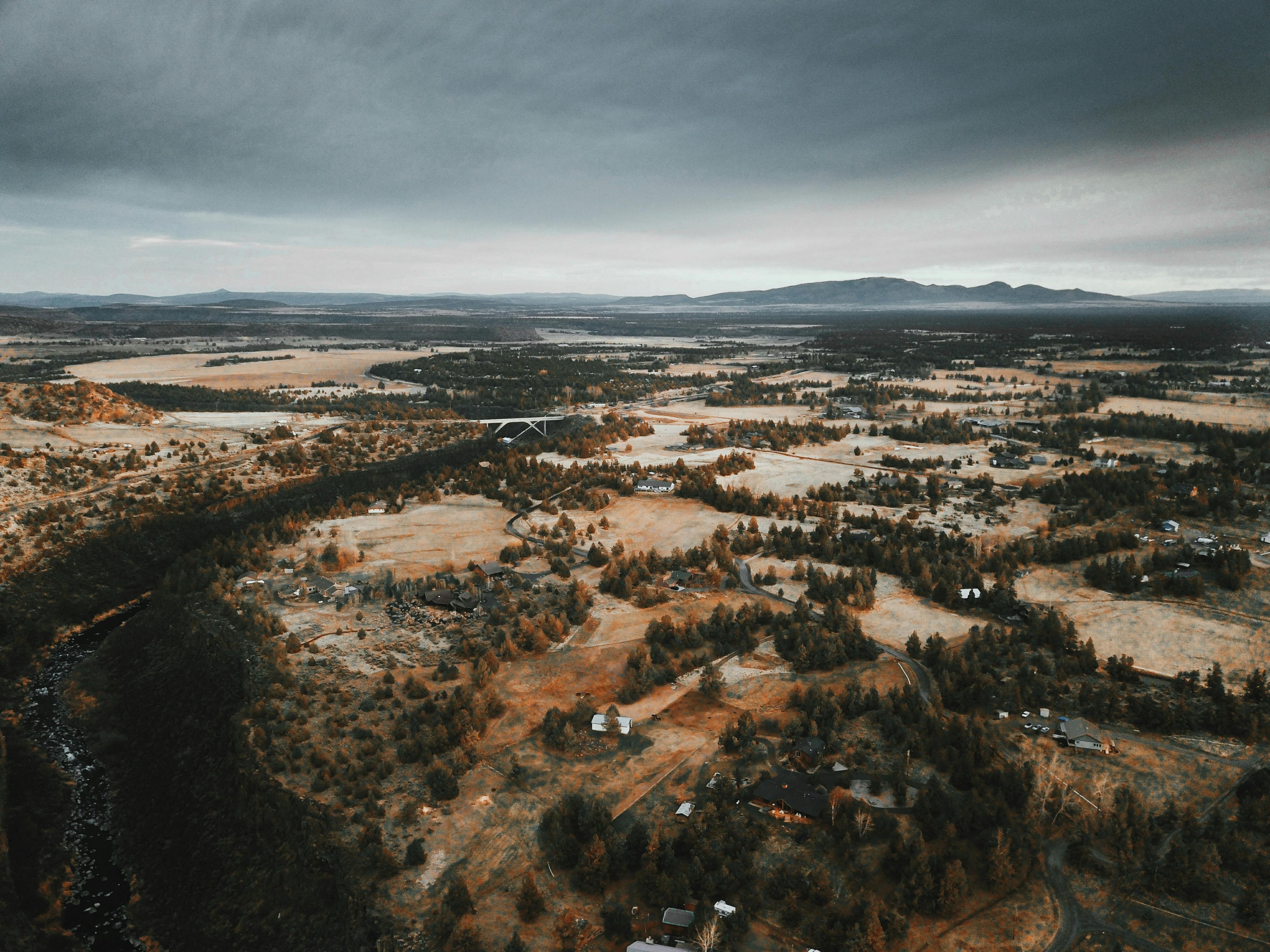 Remote countryside under dark gloomy sky · Free Stock Photo