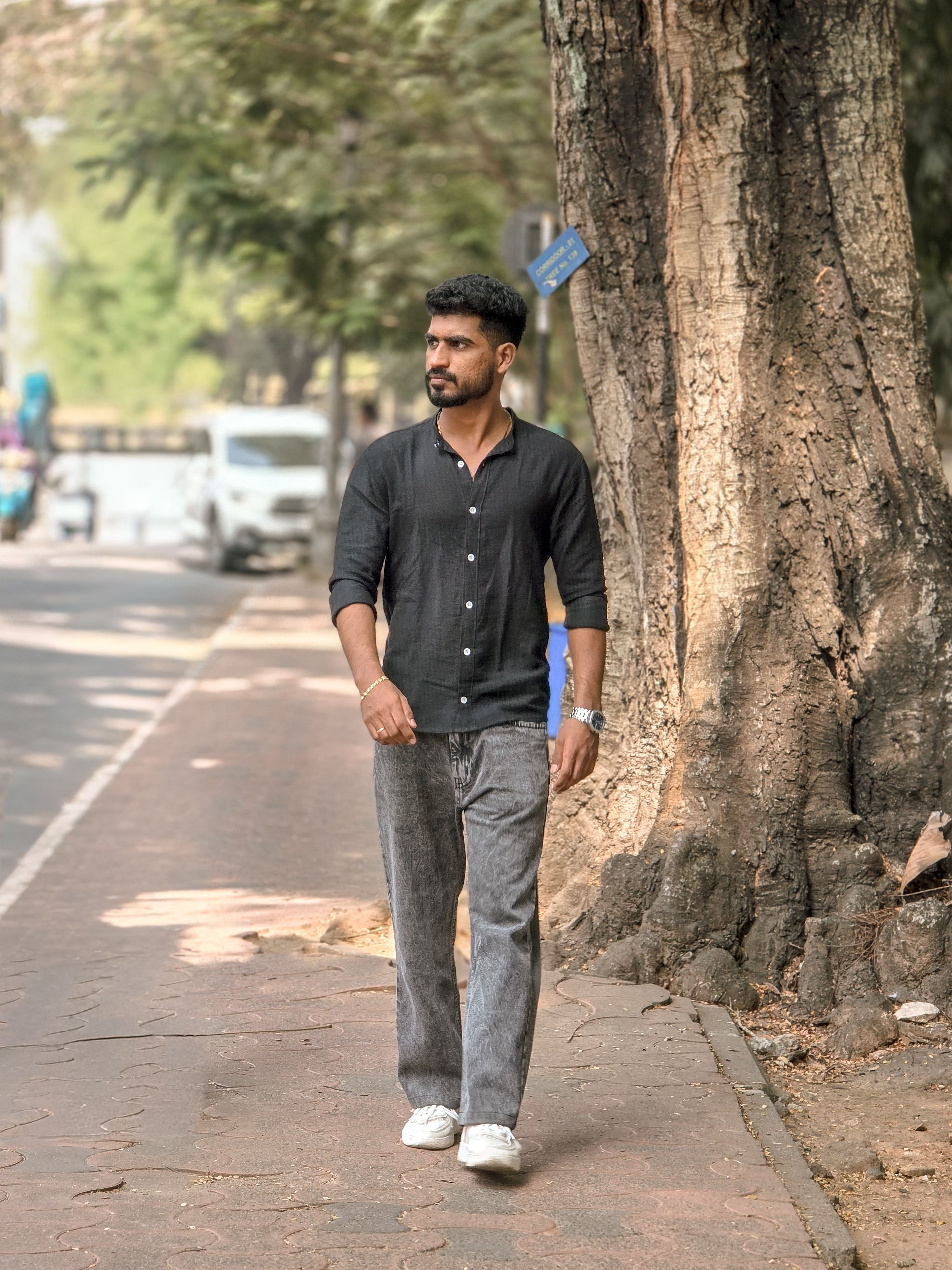Man Walking on Sidewalk Under Shady Trees · Free Stock Photo