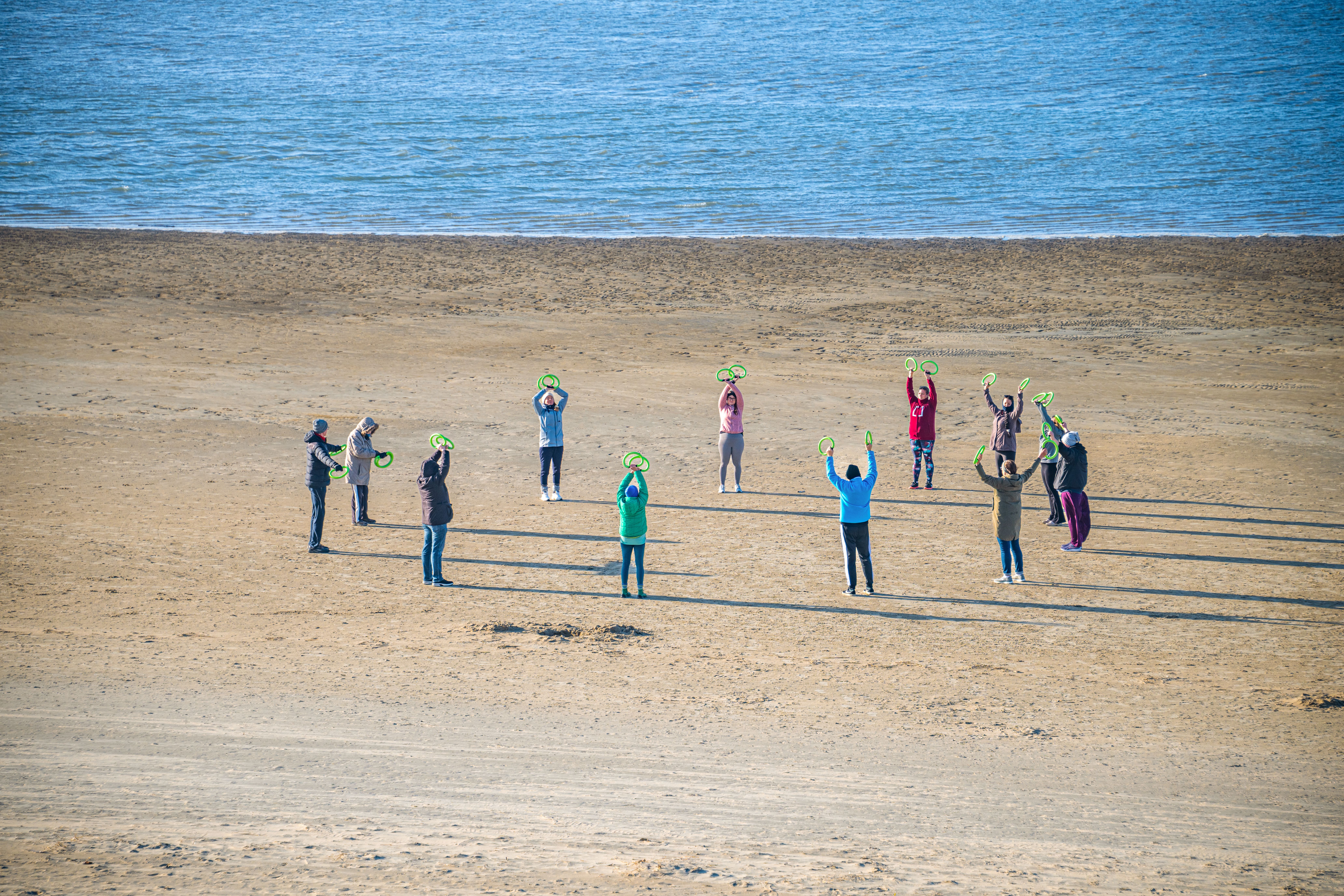 Group Exercise on a Sandy Beach in Daylight · Free Stock Photo
