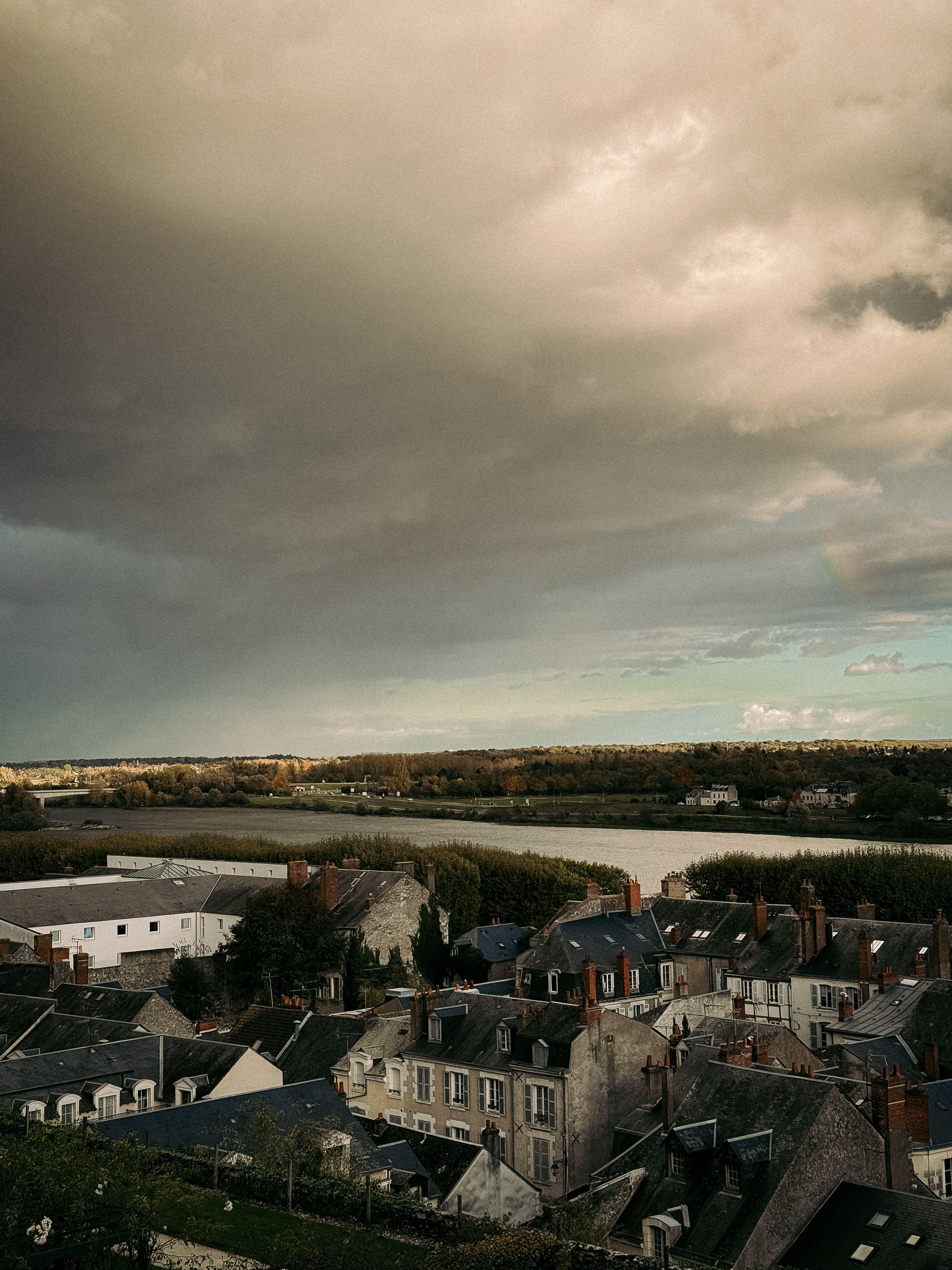Dramatic Sky Over French Town Rooftops · Free Stock Photo