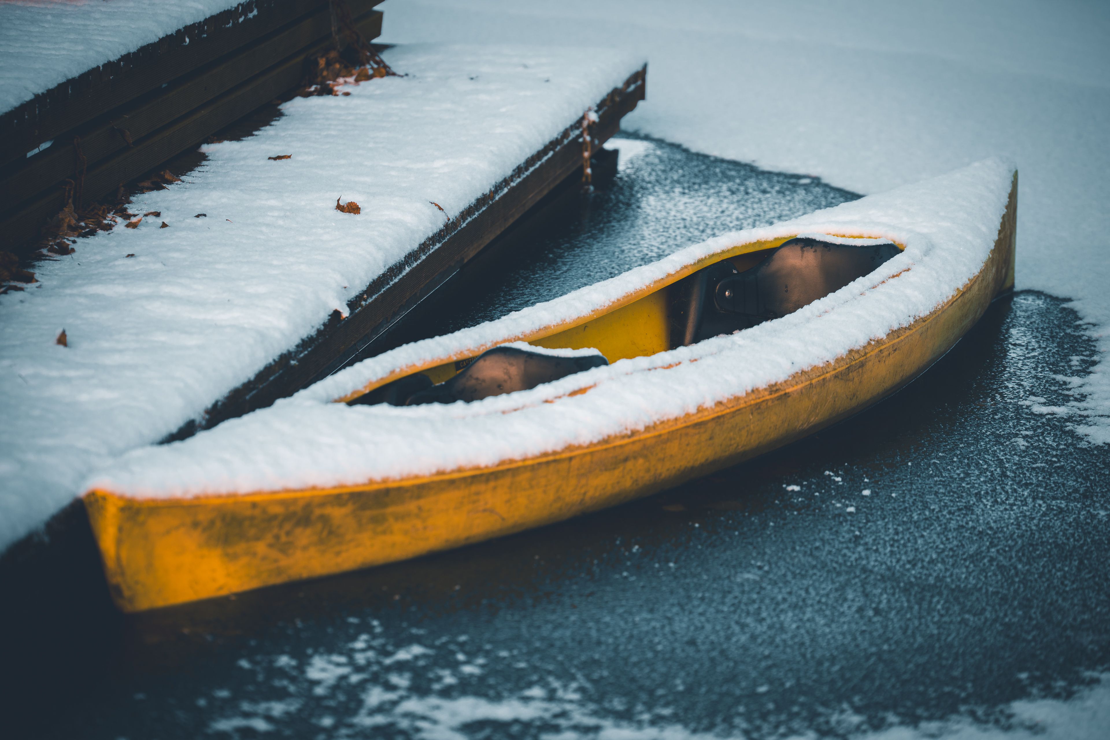 Snow-Covered Kayak by Frozen Lake in Winter · Free Stock Photo