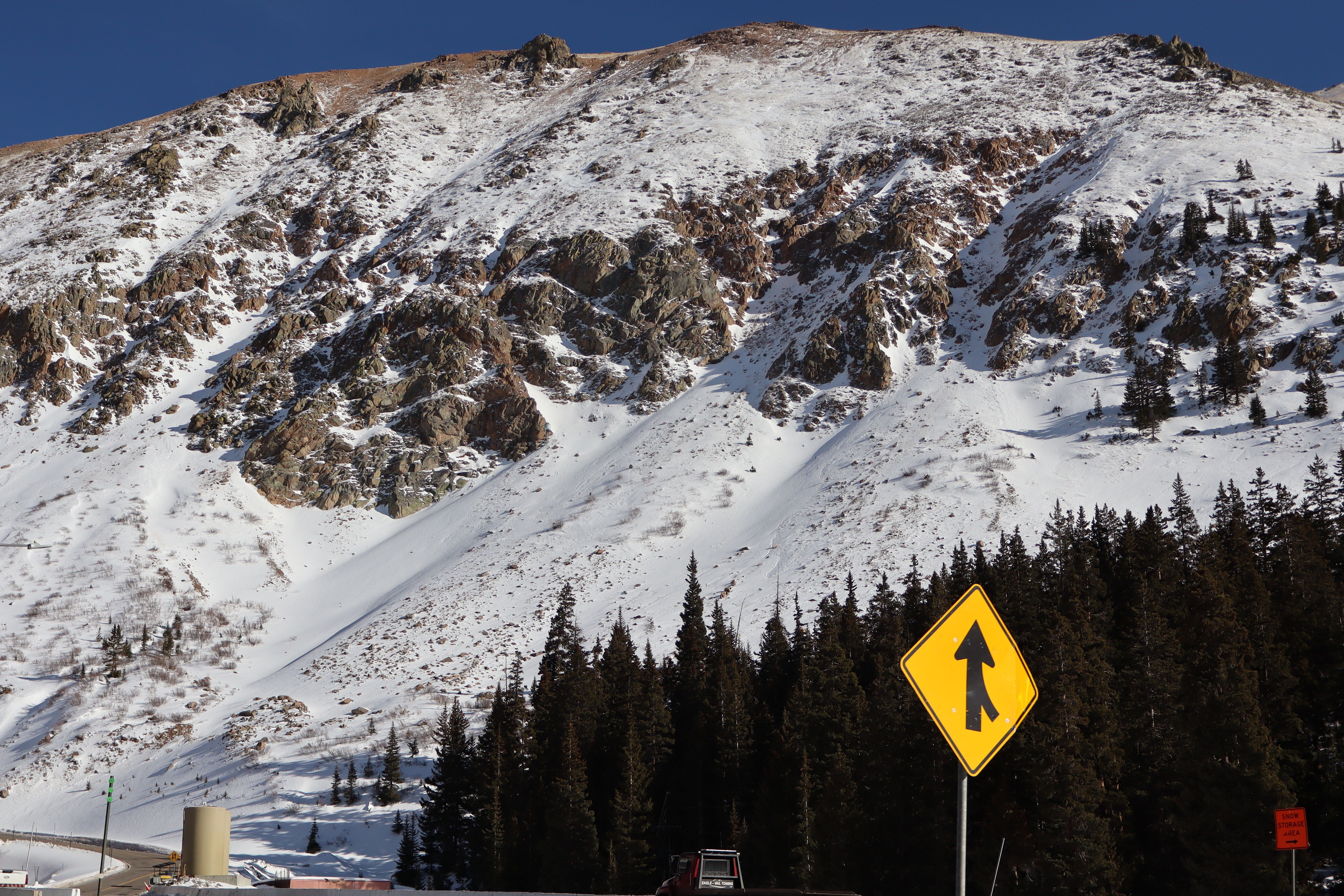 Snowy Mountain Road with Traffic Sign · Free Stock Photo