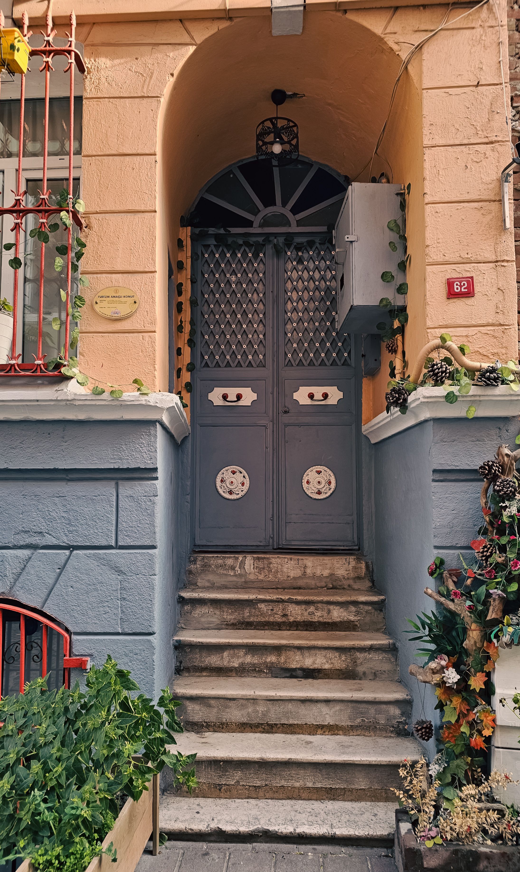 Charming European Doorway with Floral Accents · Free Stock Photo