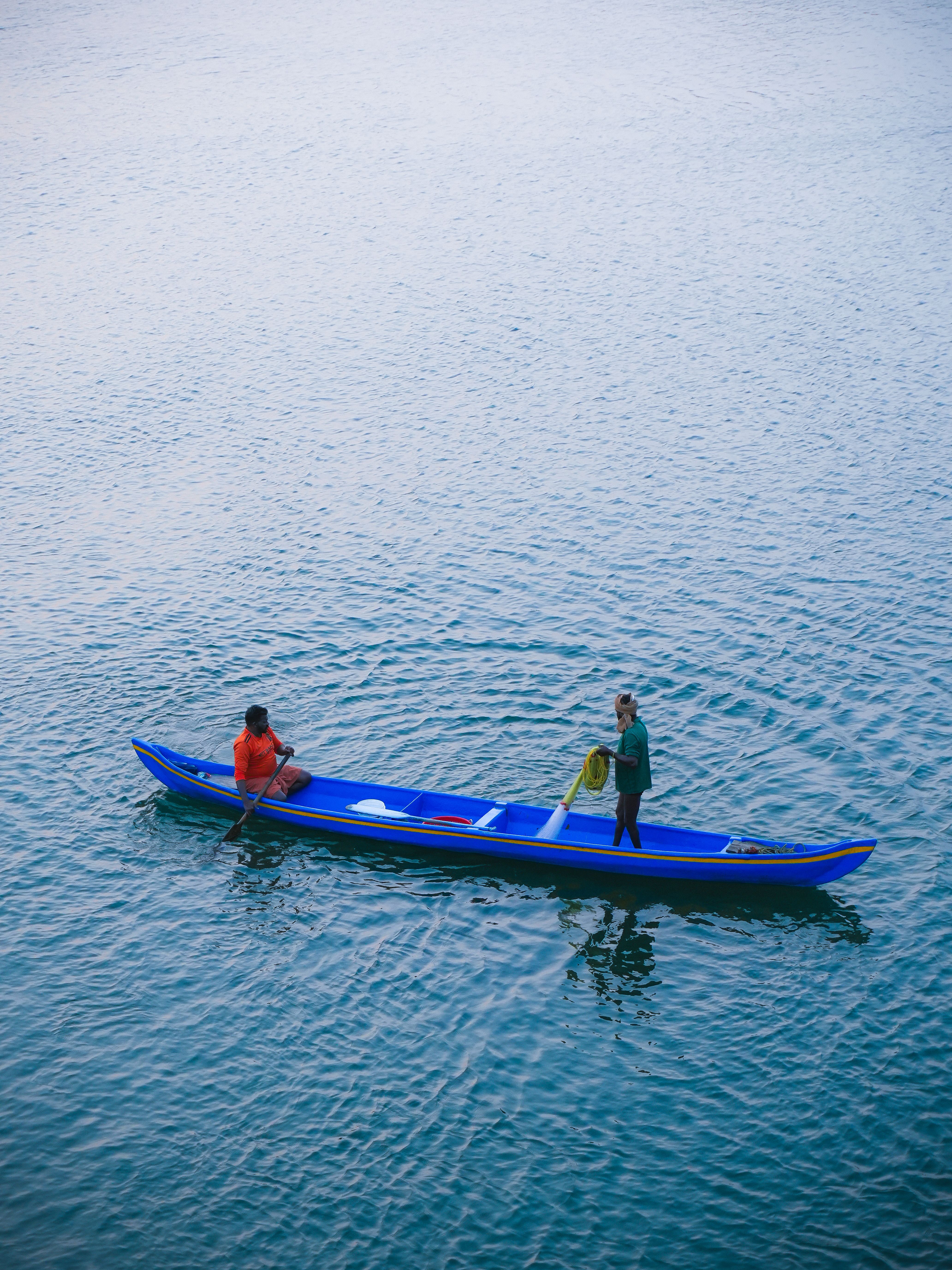 Two People Canoeing on Serene Lake · Free Stock Photo