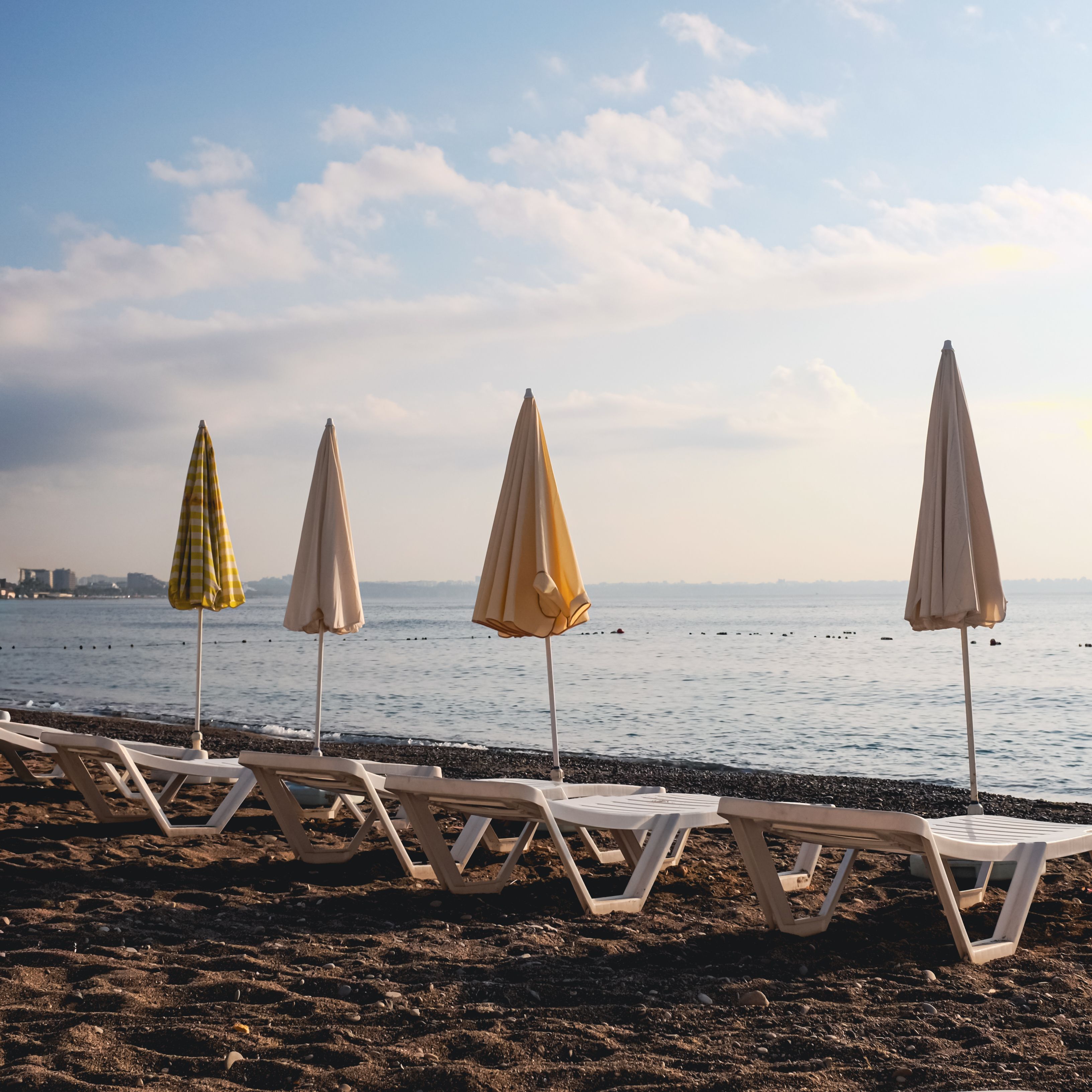 Serene Beach with Empty Sun Loungers at Sunrise · Free Stock Photo