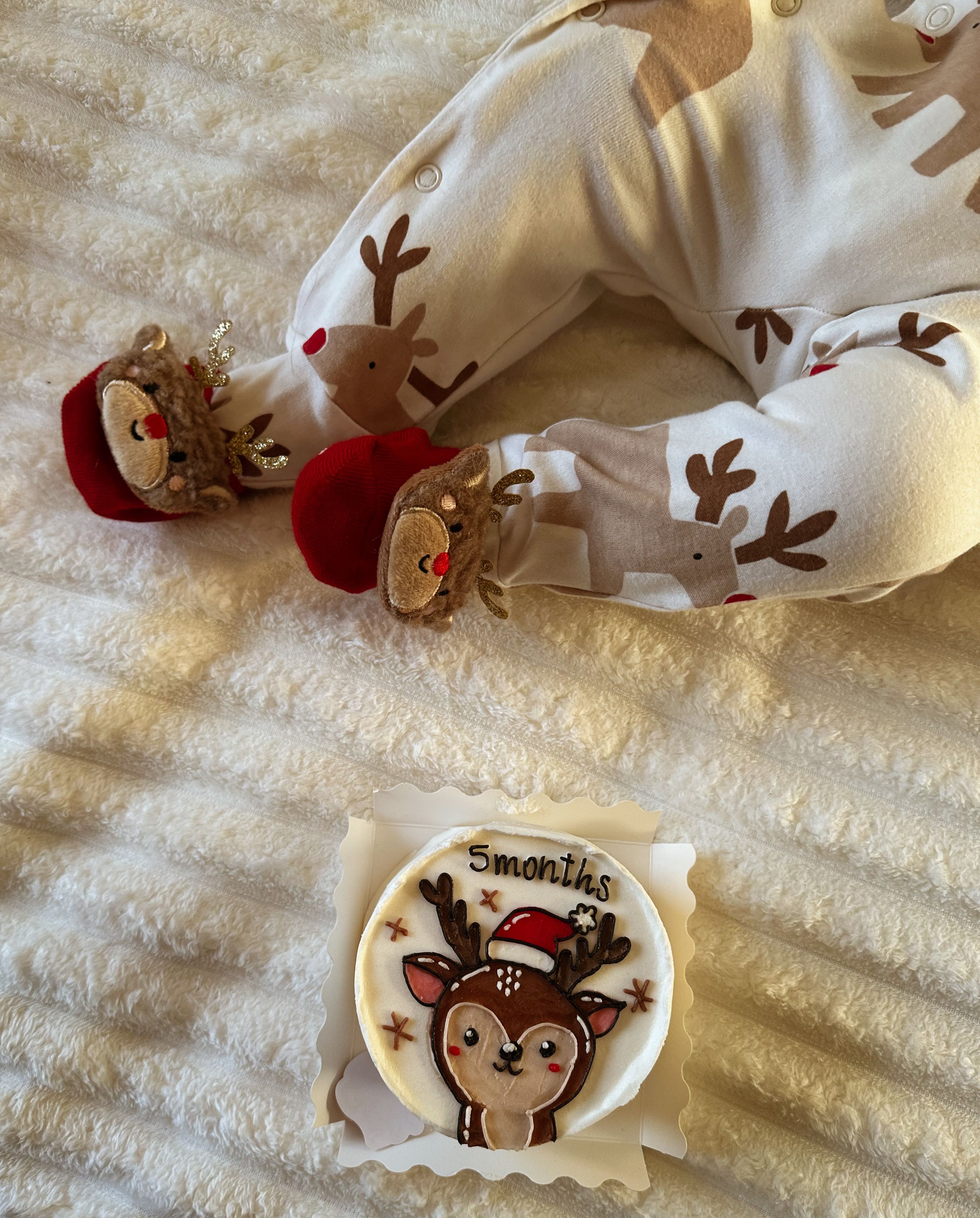 Adorable Baby in Reindeer Outfit Celebrating Milestone · Free Stock Photo