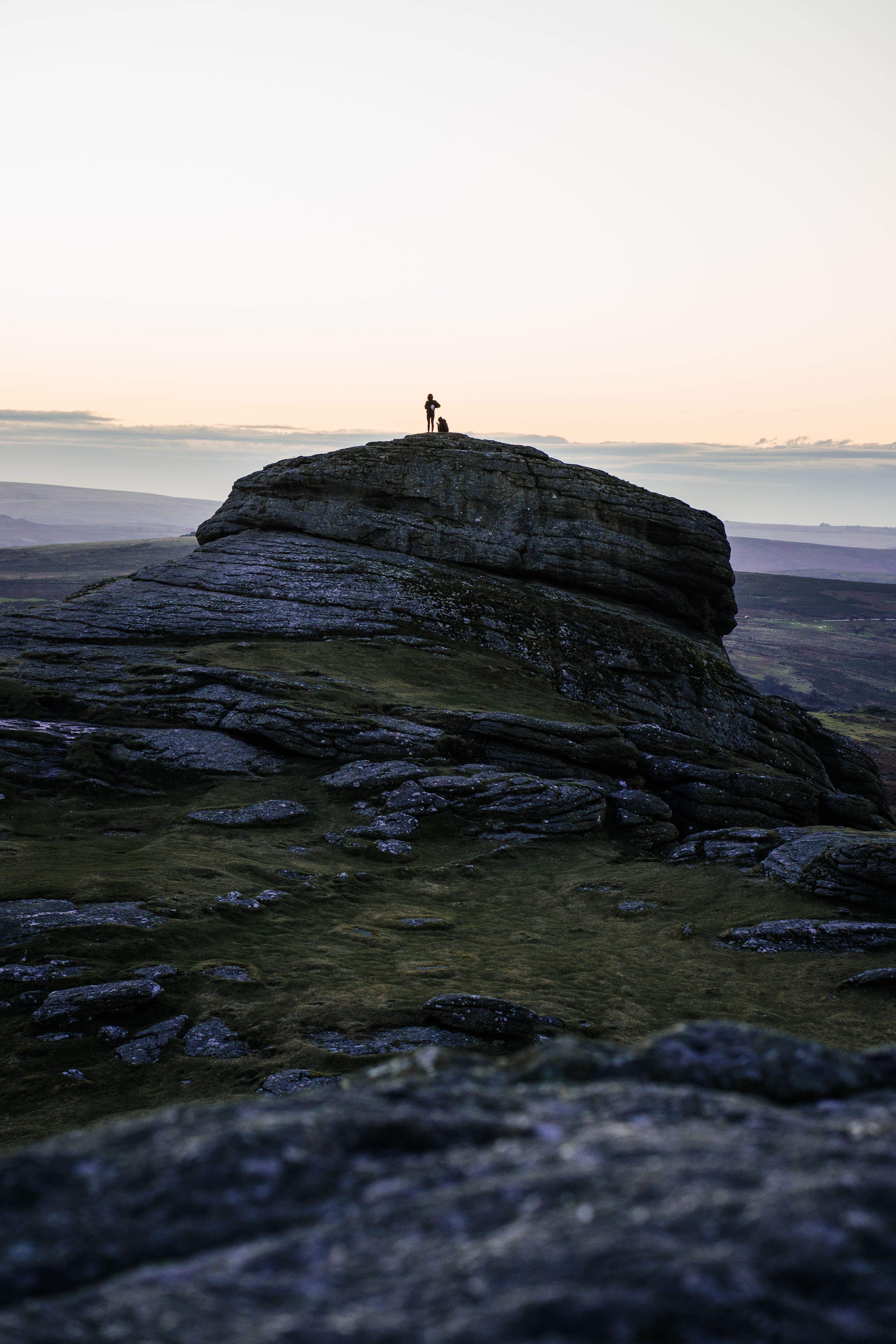 Hiker Standing atop Rocky Tor at Twilight · Free Stock Photo
