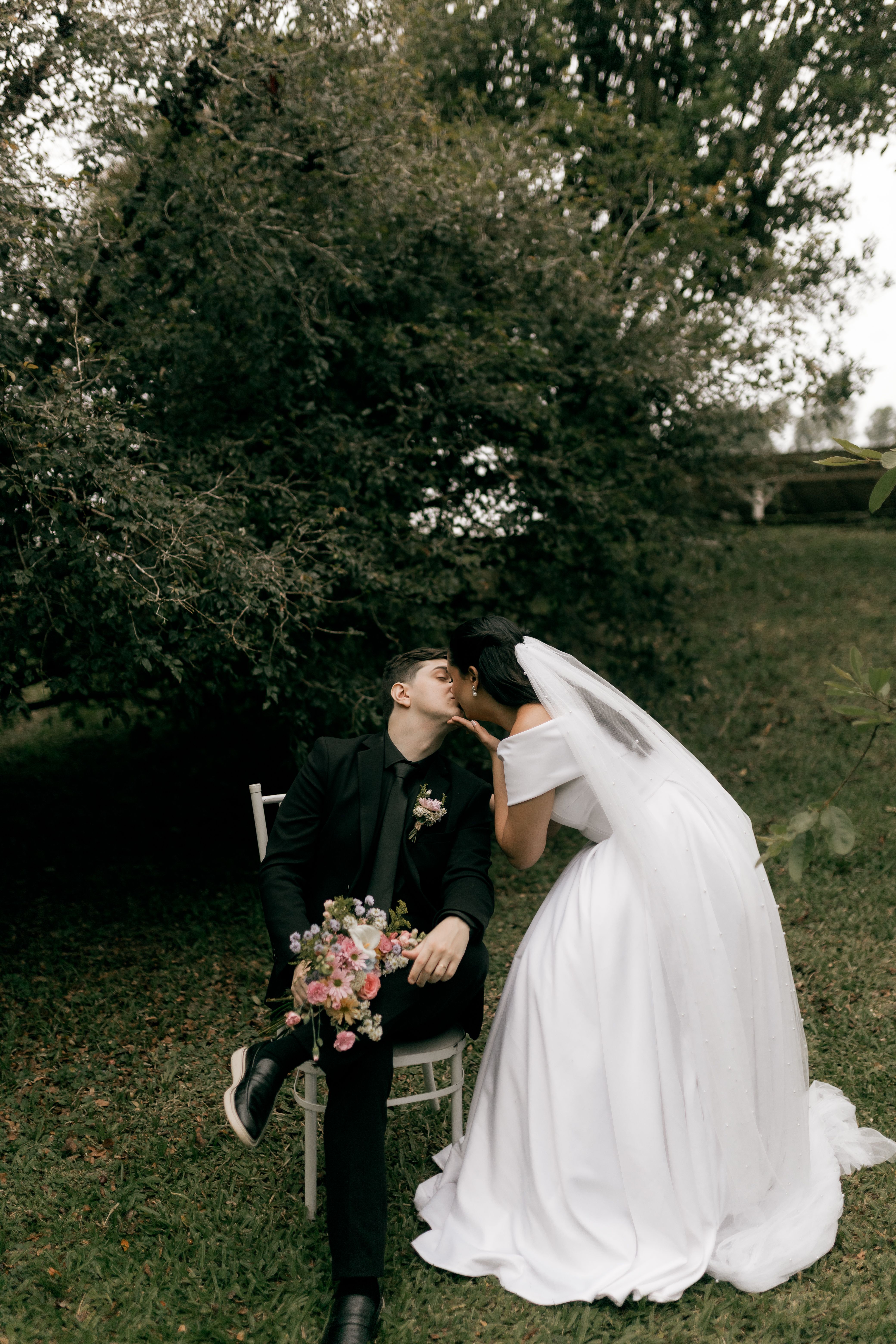 Romantic Outdoor Wedding Kiss Among Trees · Free Stock Photo