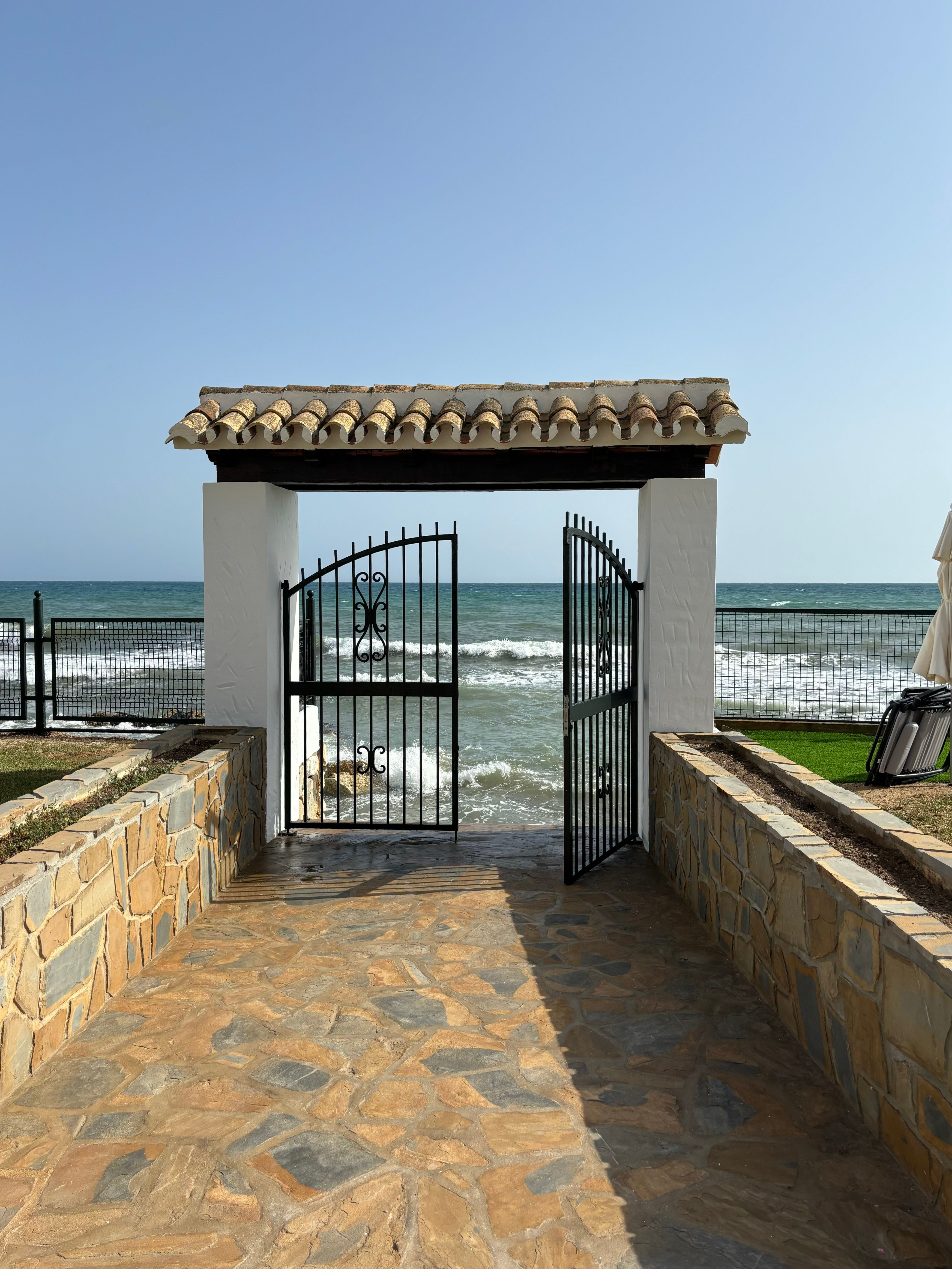 Coastal View Through a Decorative Iron Gate · Free Stock Photo