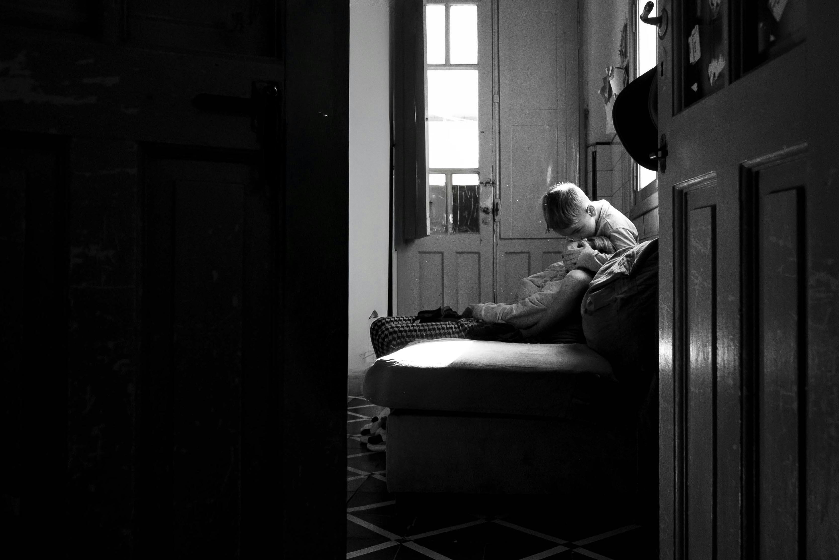 Black and White Child Reading by Window Light · Free Stock Photo