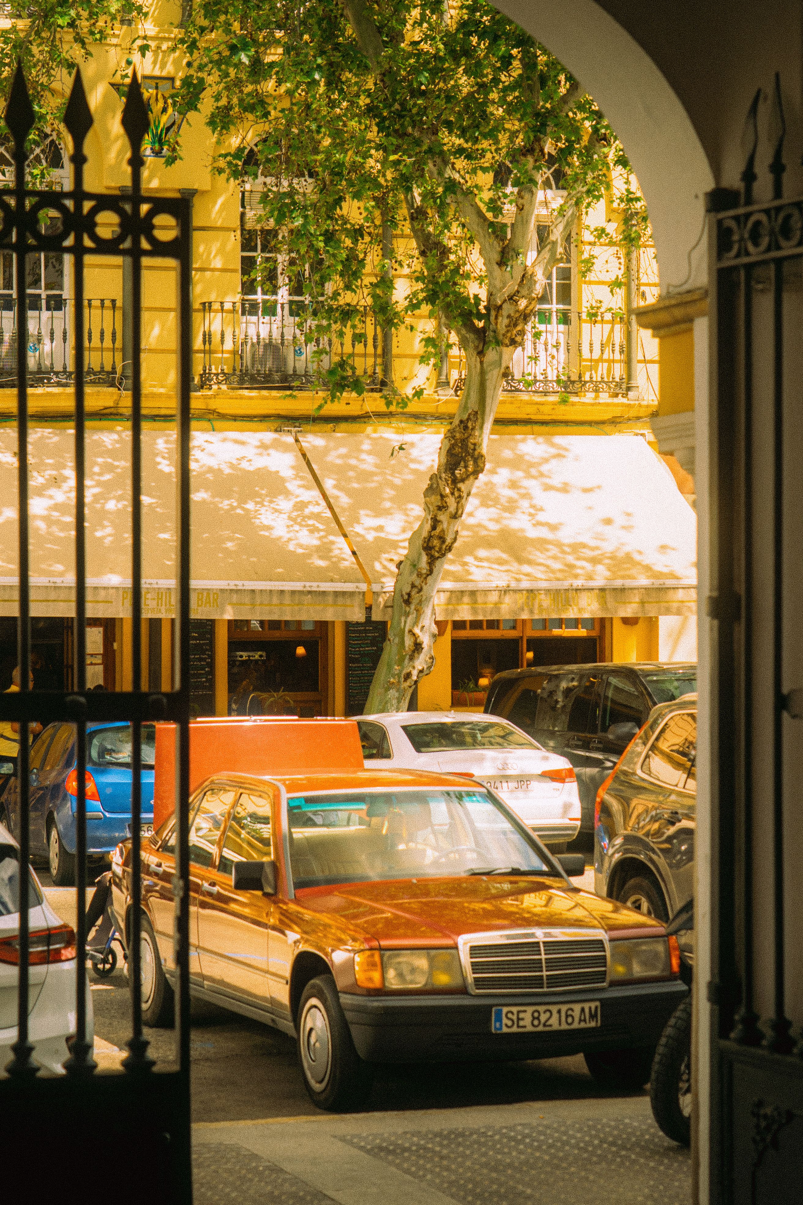Charming Seville Street View with Classic Car · Free Stock Photo