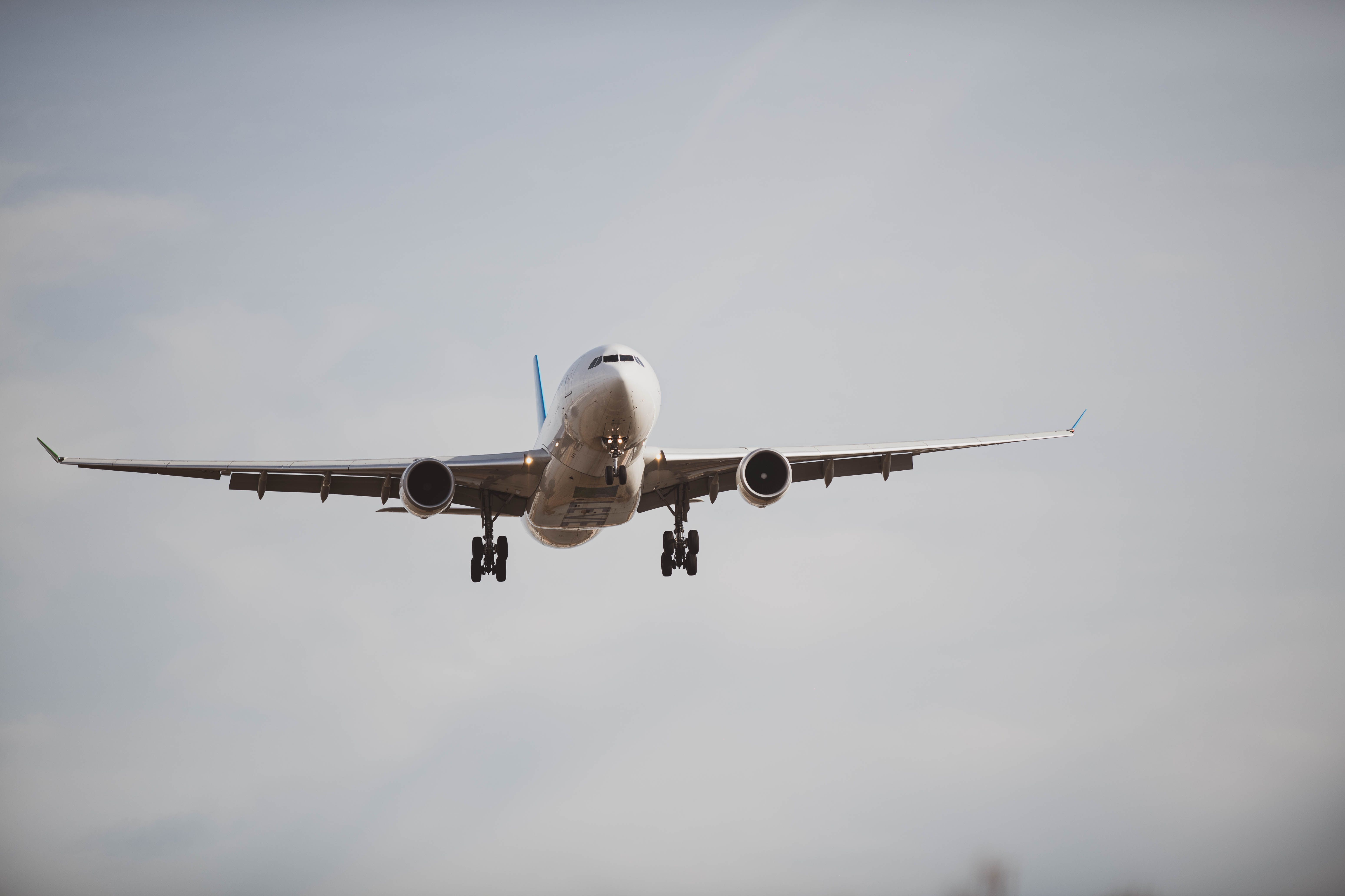 Commercial Airplane in Flight Against Cloudy Sky · Free Stock Photo