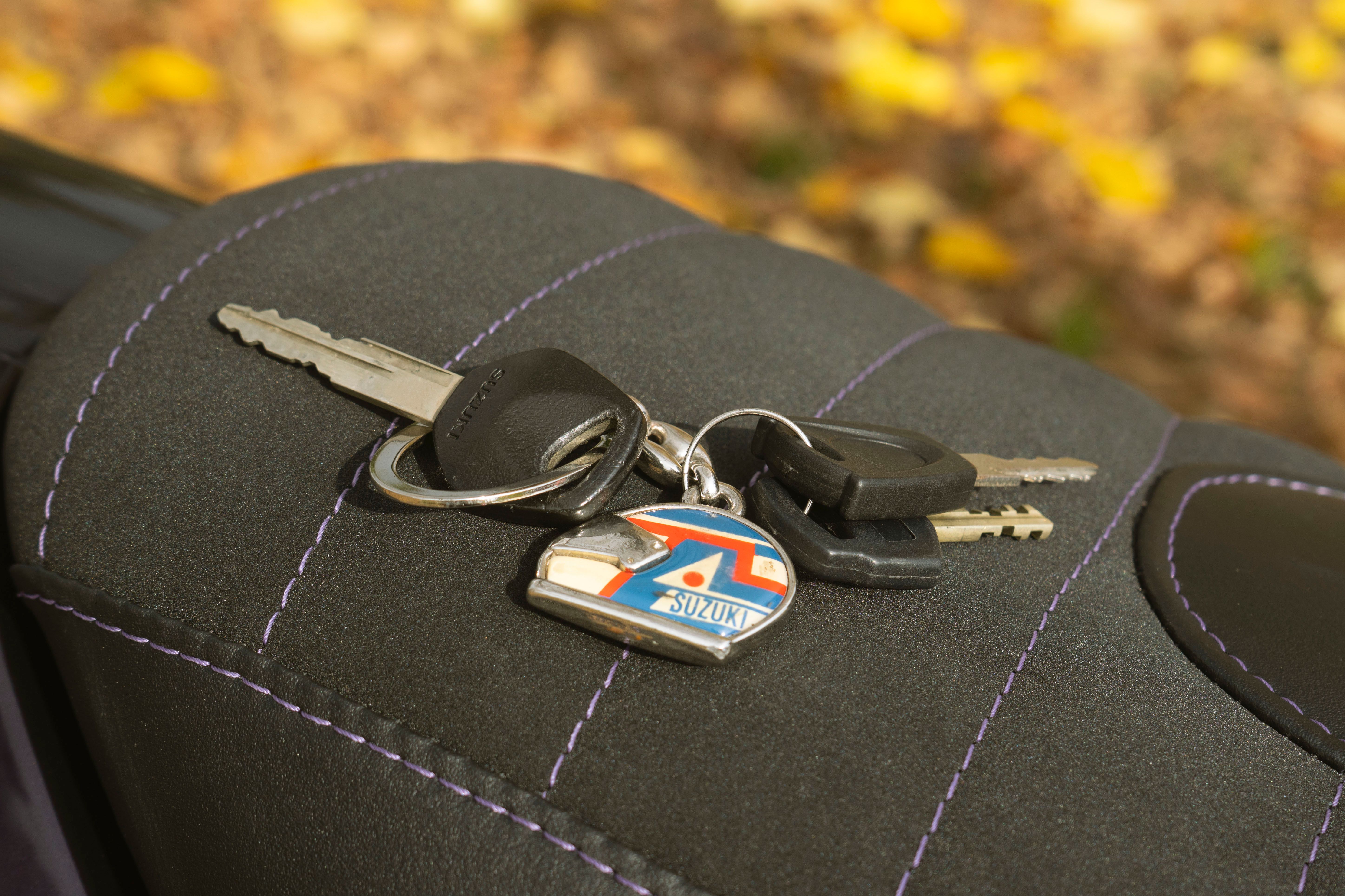 Close-up of Motorcycle Keys on Seat with Logo · Free Stock Photo