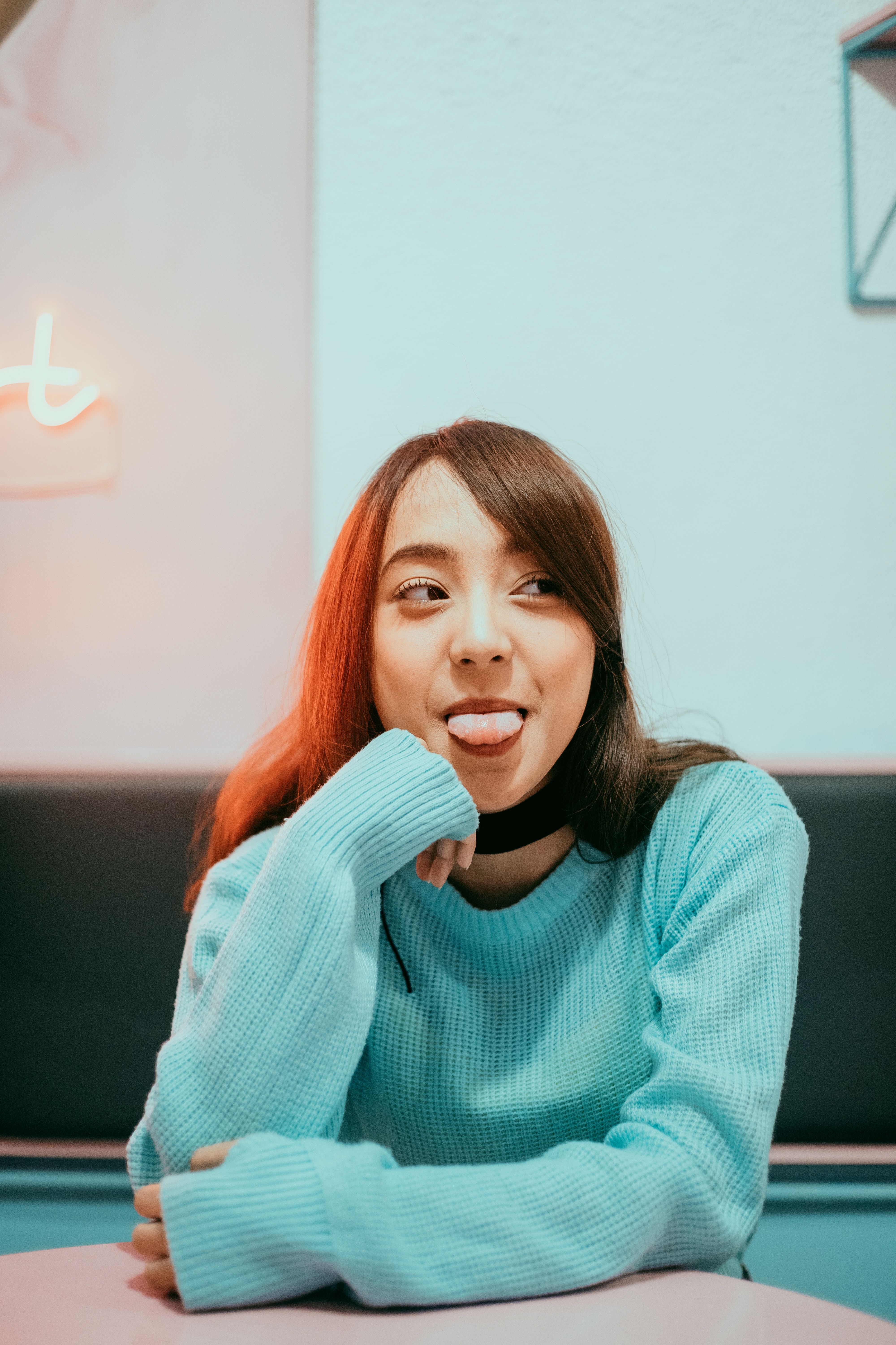 Photo Of Woman With Her Eyes Closed Sticking Her Tongue Out · Free