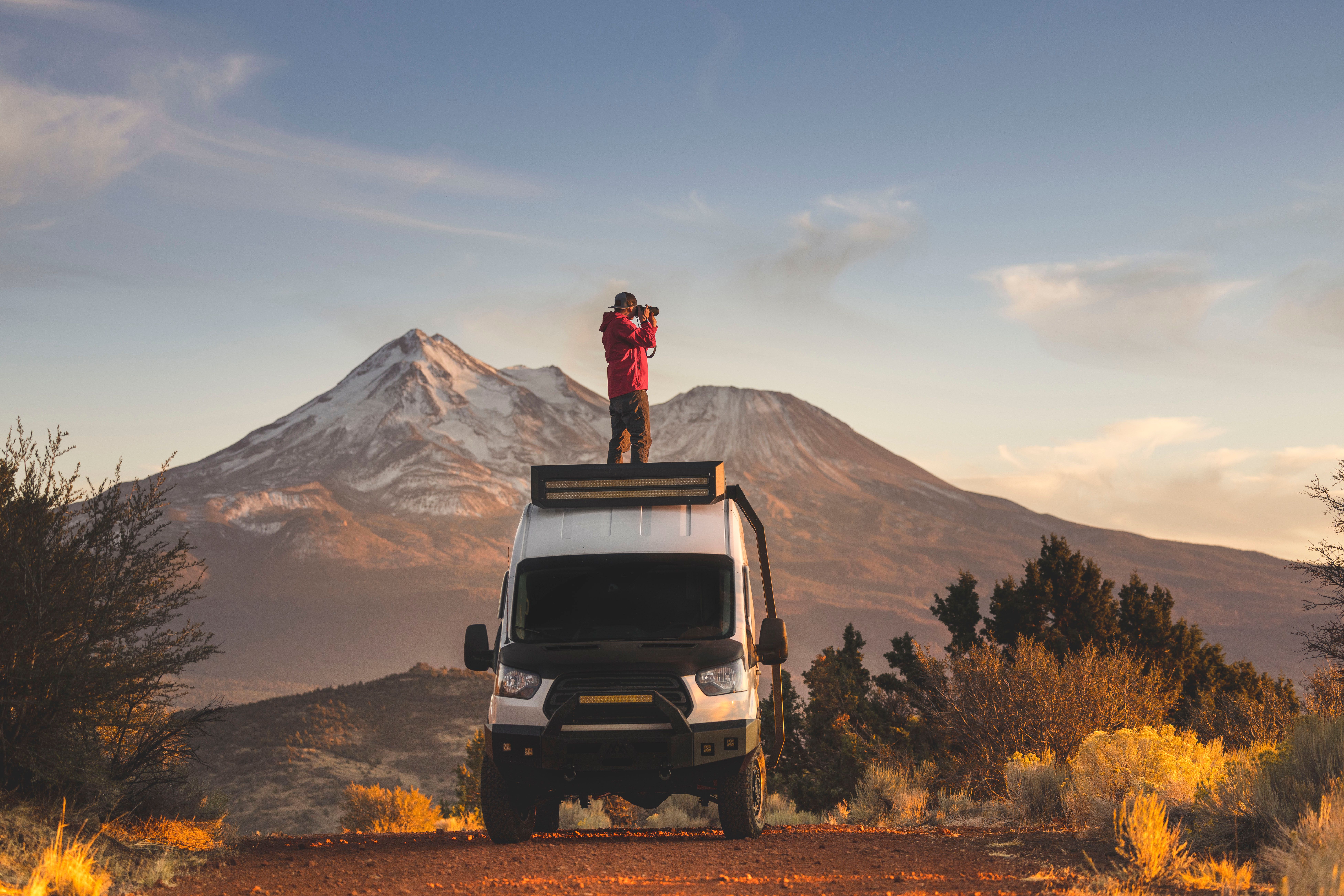 Photographer on Van Capturing Mountain Landscape · Free Stock Photo