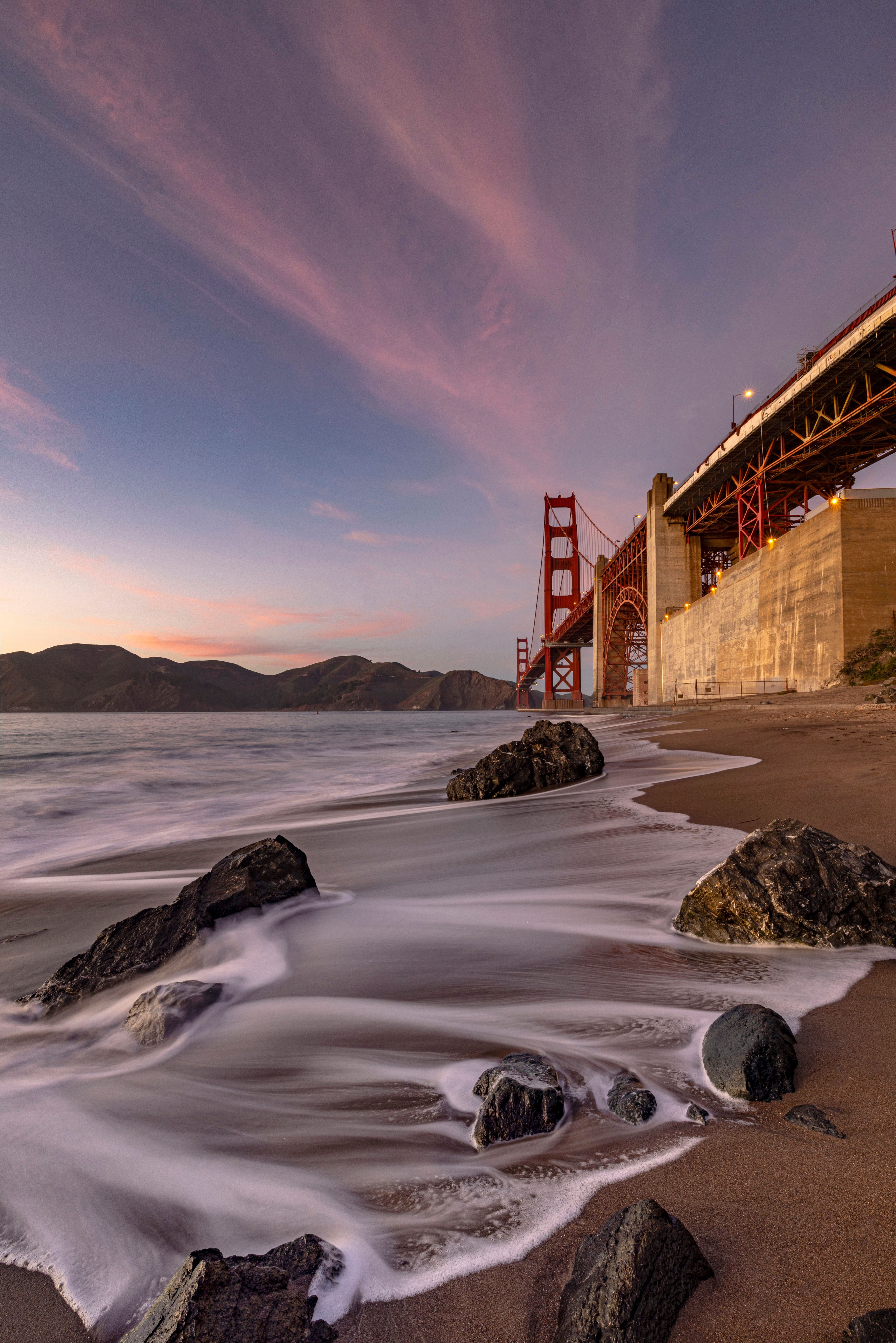 Golden Gate Bridge at Dusk with Soft Ocean Waves · Free Stock Photo