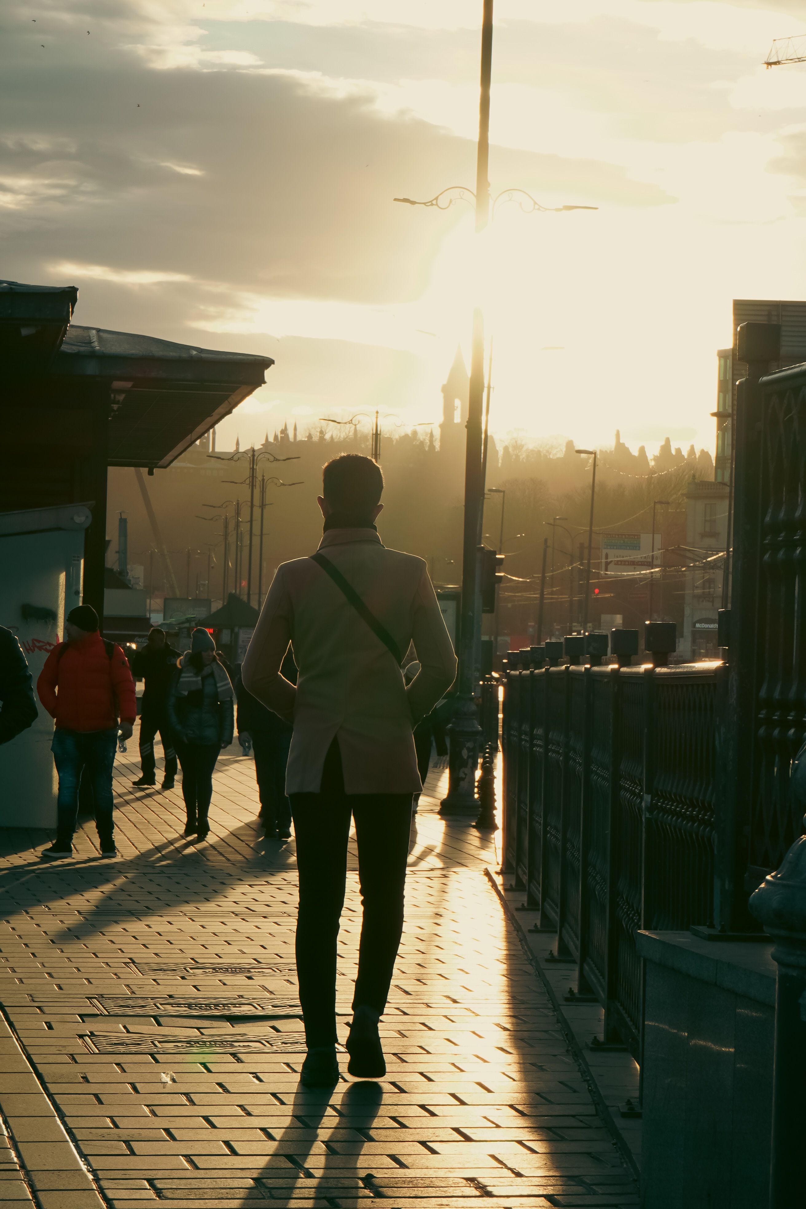 Silhouetted Figures Walking in Urban Sunset · Free Stock Photo