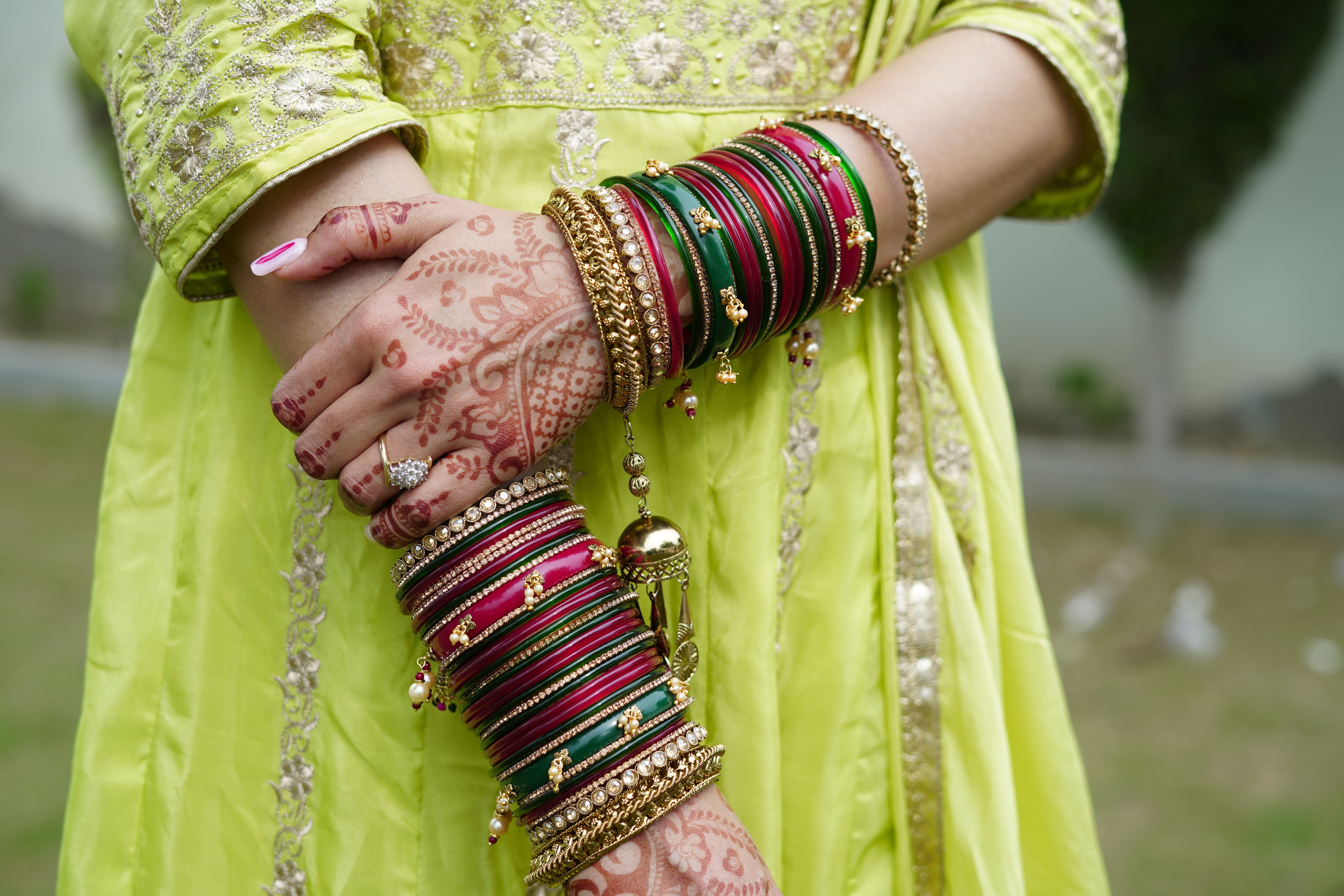 Close-up of Colorful Bangles and Henna Design · Free Stock Photo