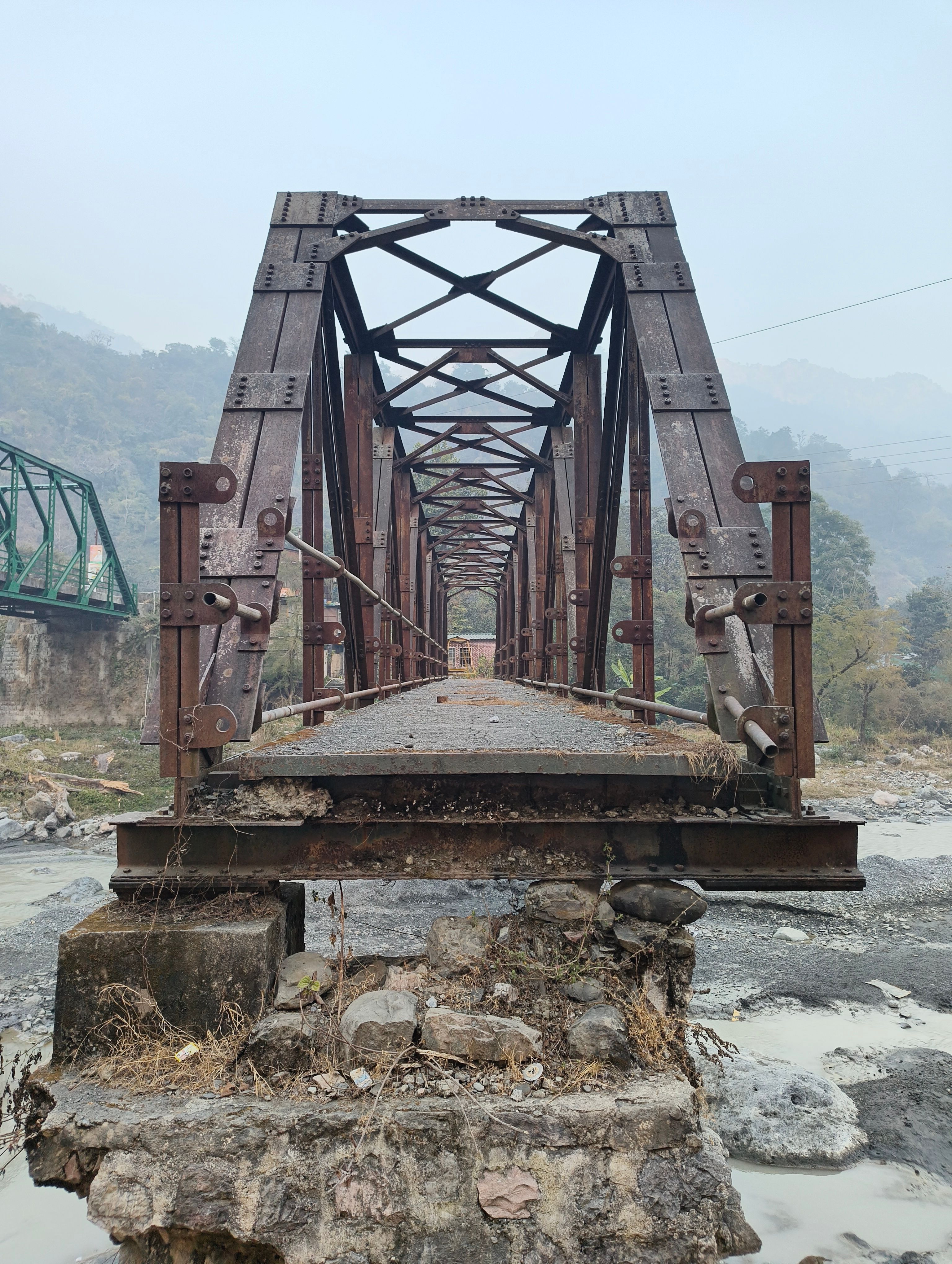 Rustic Metal Bridge Across Rocky Riverbed · Free Stock Photo