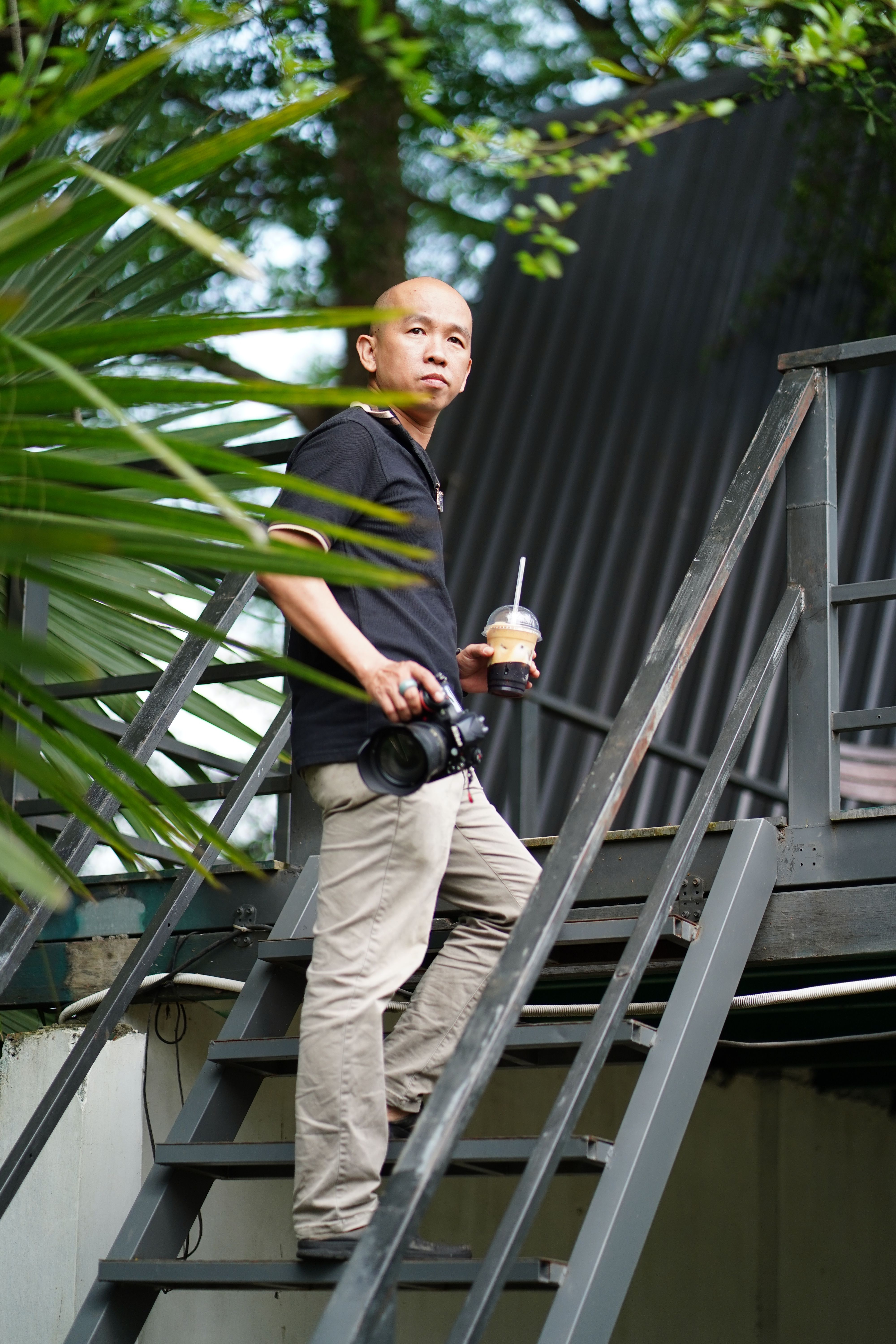 Photographer on Outdoor Staircase with Camera · Free Stock Photo