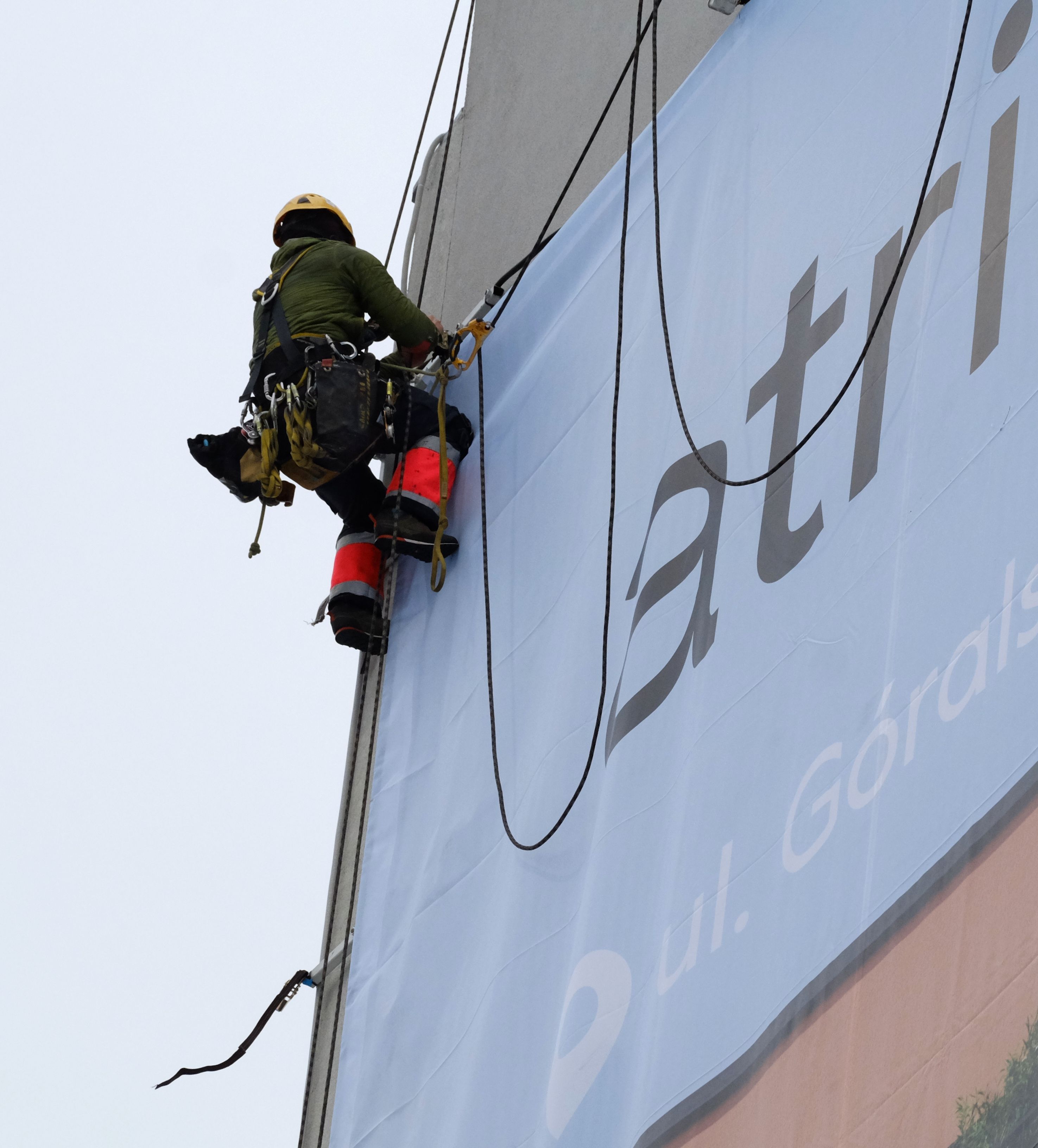 Rope Access Worker Installing Large Outdoor Banner · Free Stock Photo