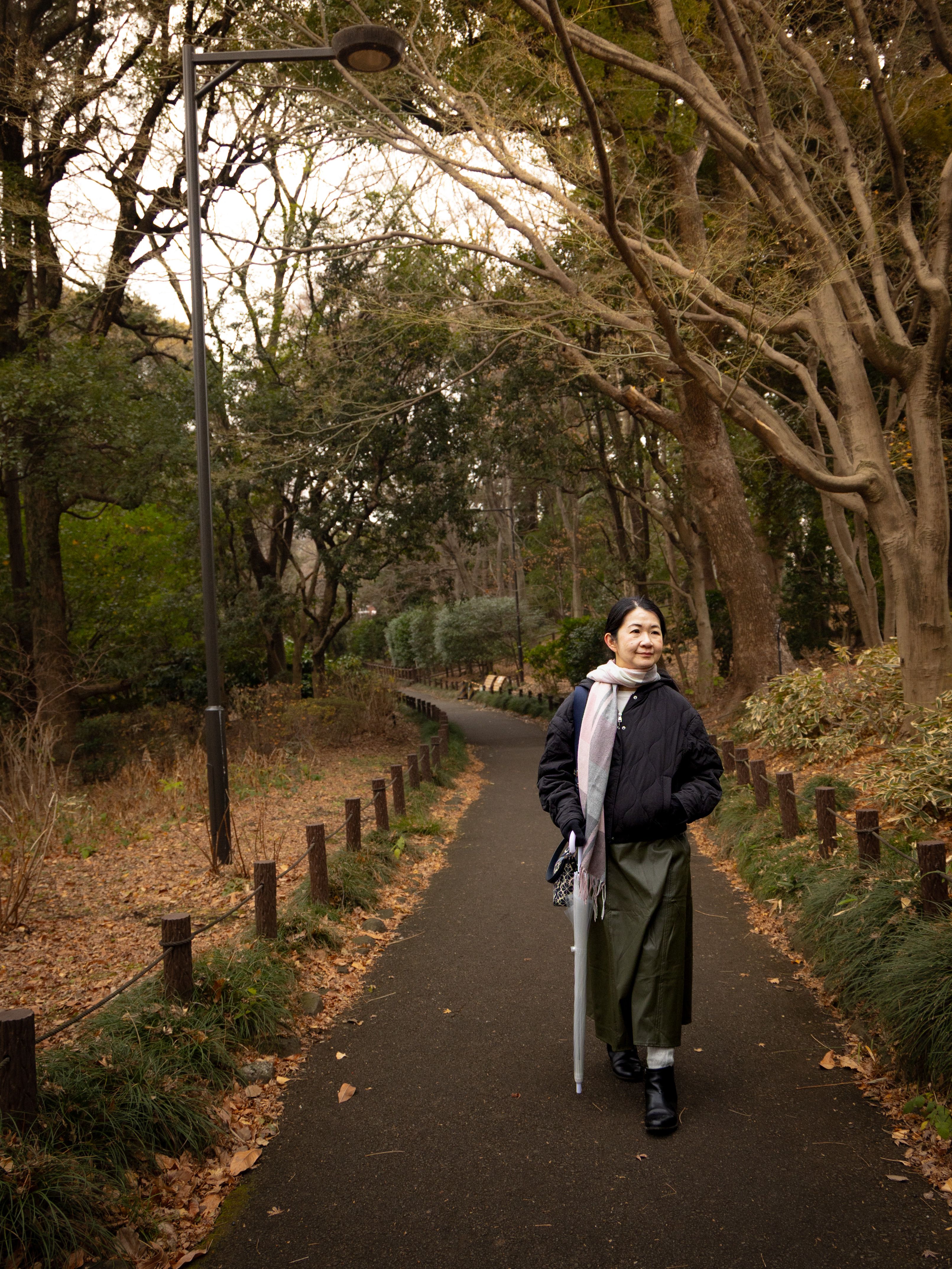 Woman Walking with Cane on a Forest Path · Free Stock Photo