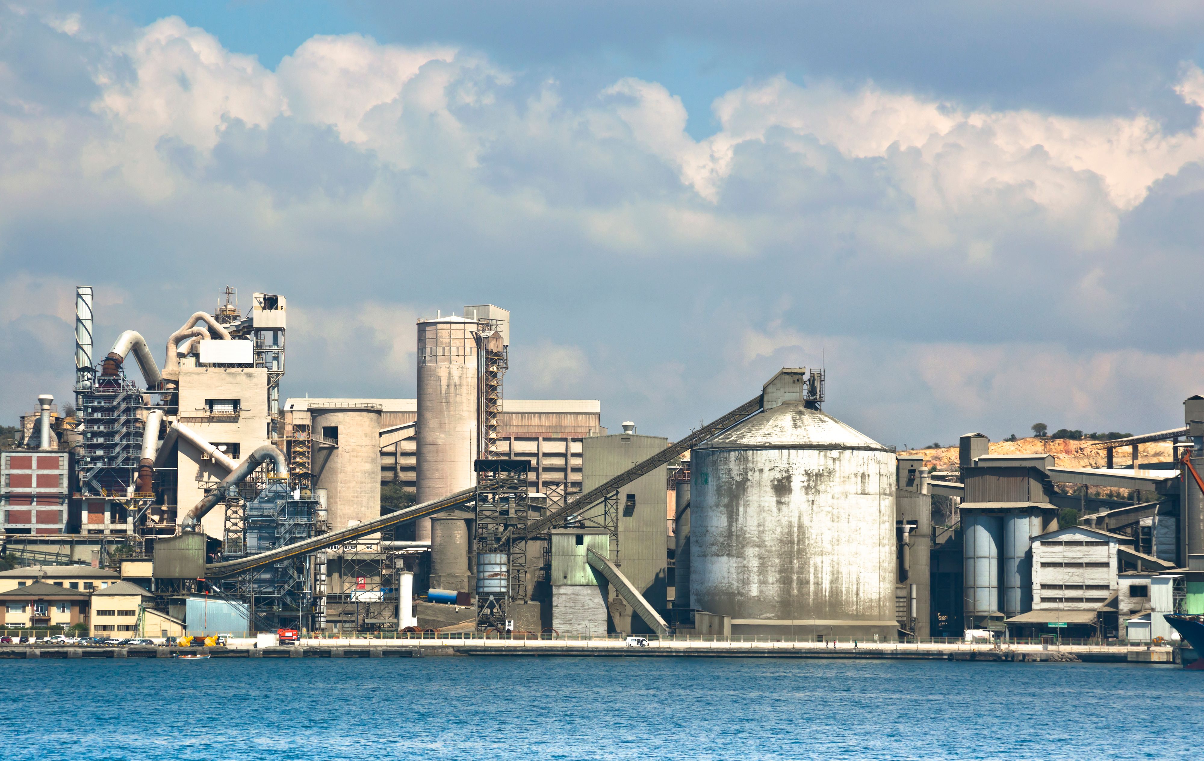Industrial Factory by the Sea on Overcast Day · Free Stock Photo