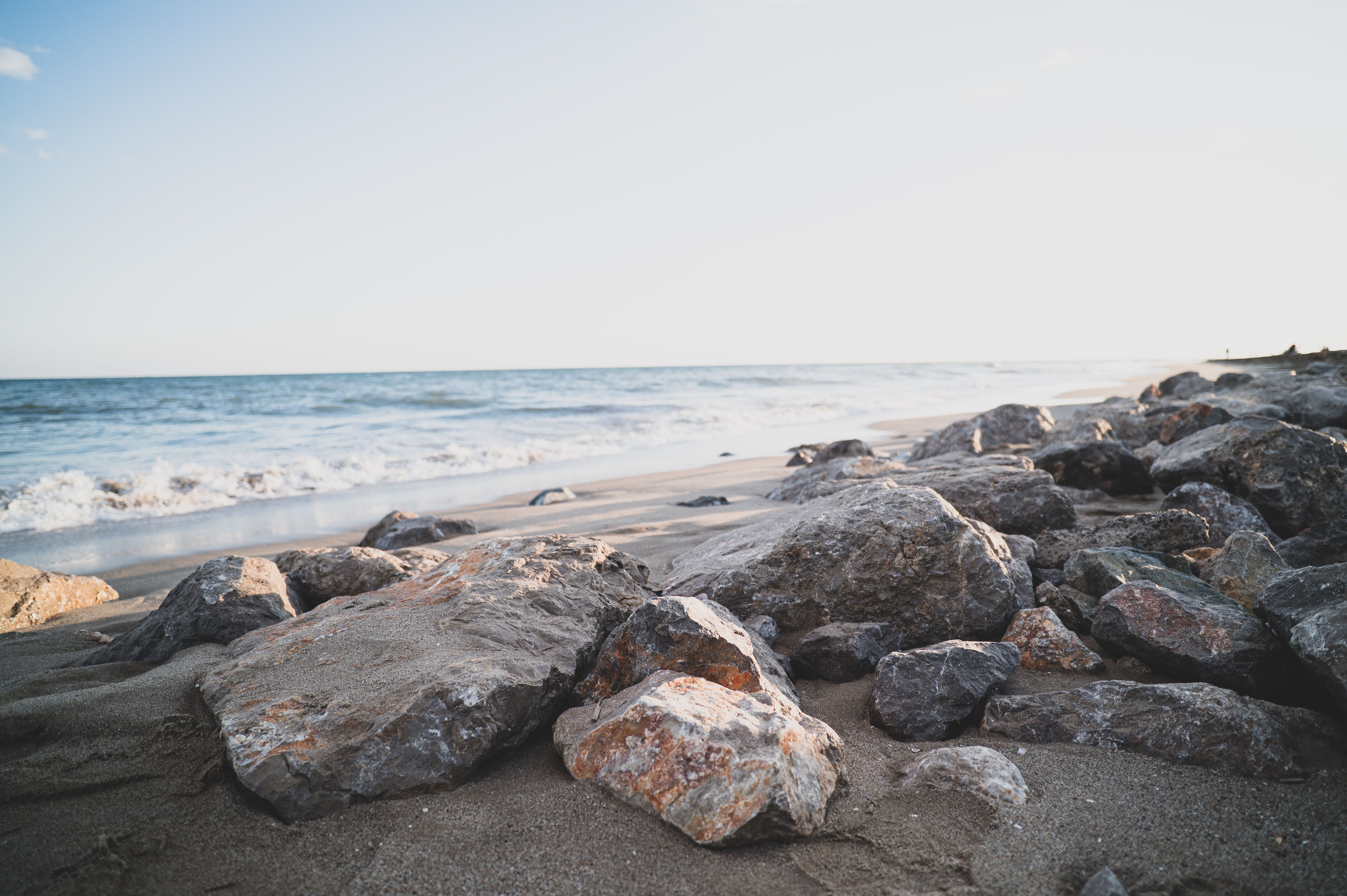 Scenic Rock Beach Shoreline During Daytime · Free Stock Photo