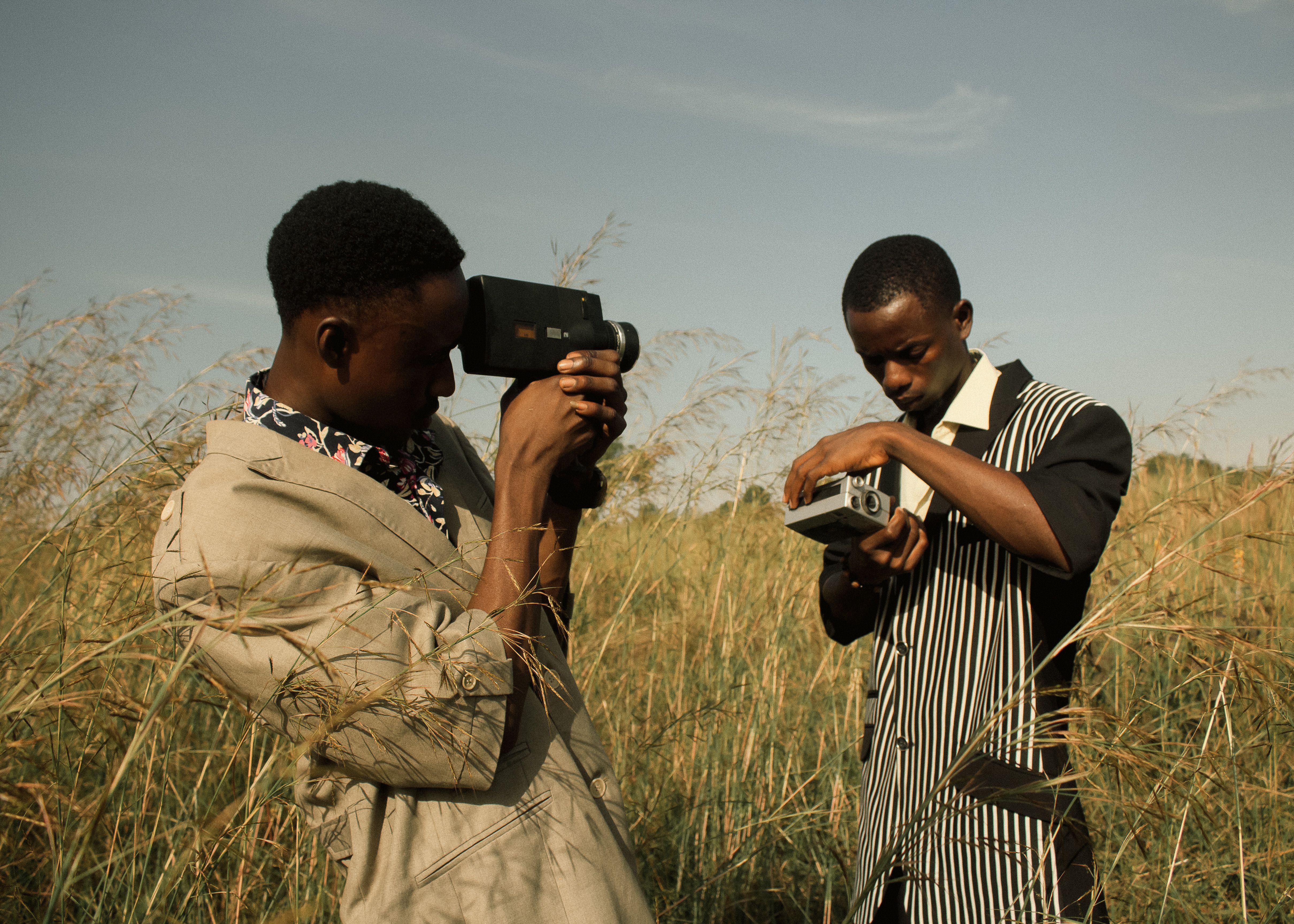 Vintage Cameras in Open Field, Creative Fashion Shoot · Free Stock Photo