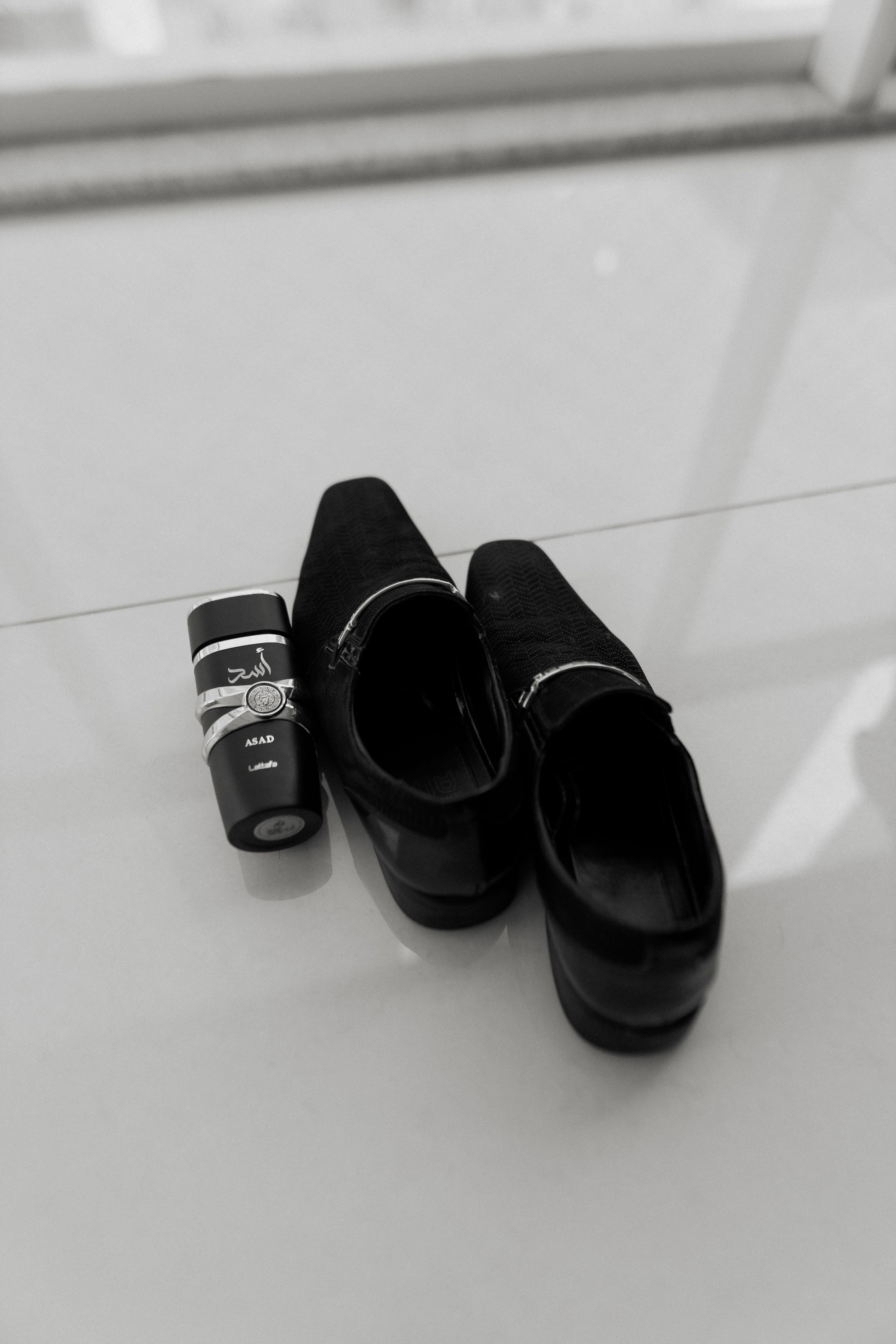 Elegant Black Shoes and Perfume on Marble Floor · Free Stock Photo