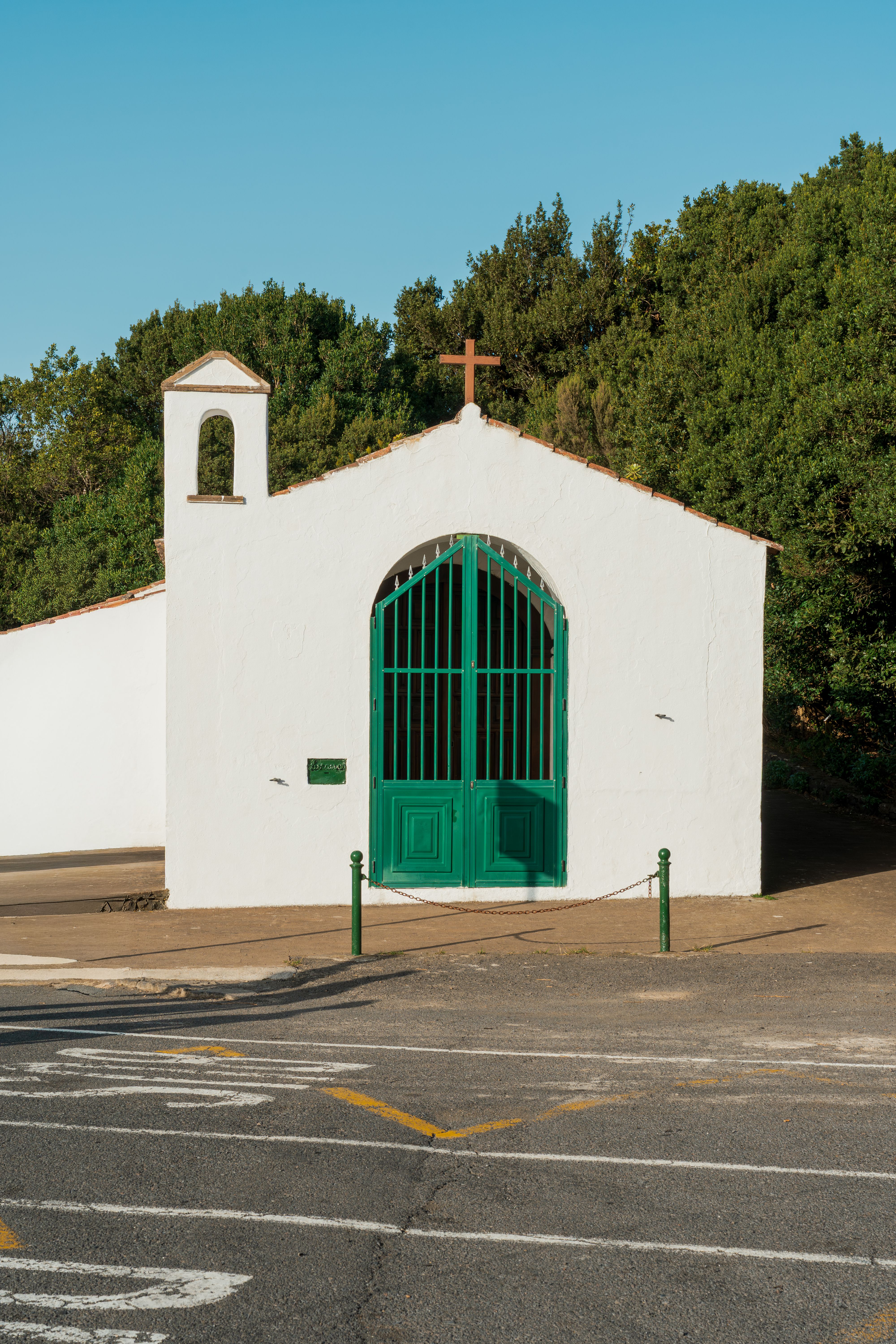 Charming White Chapel with Green Door and Bell Tower · Free Stock Photo