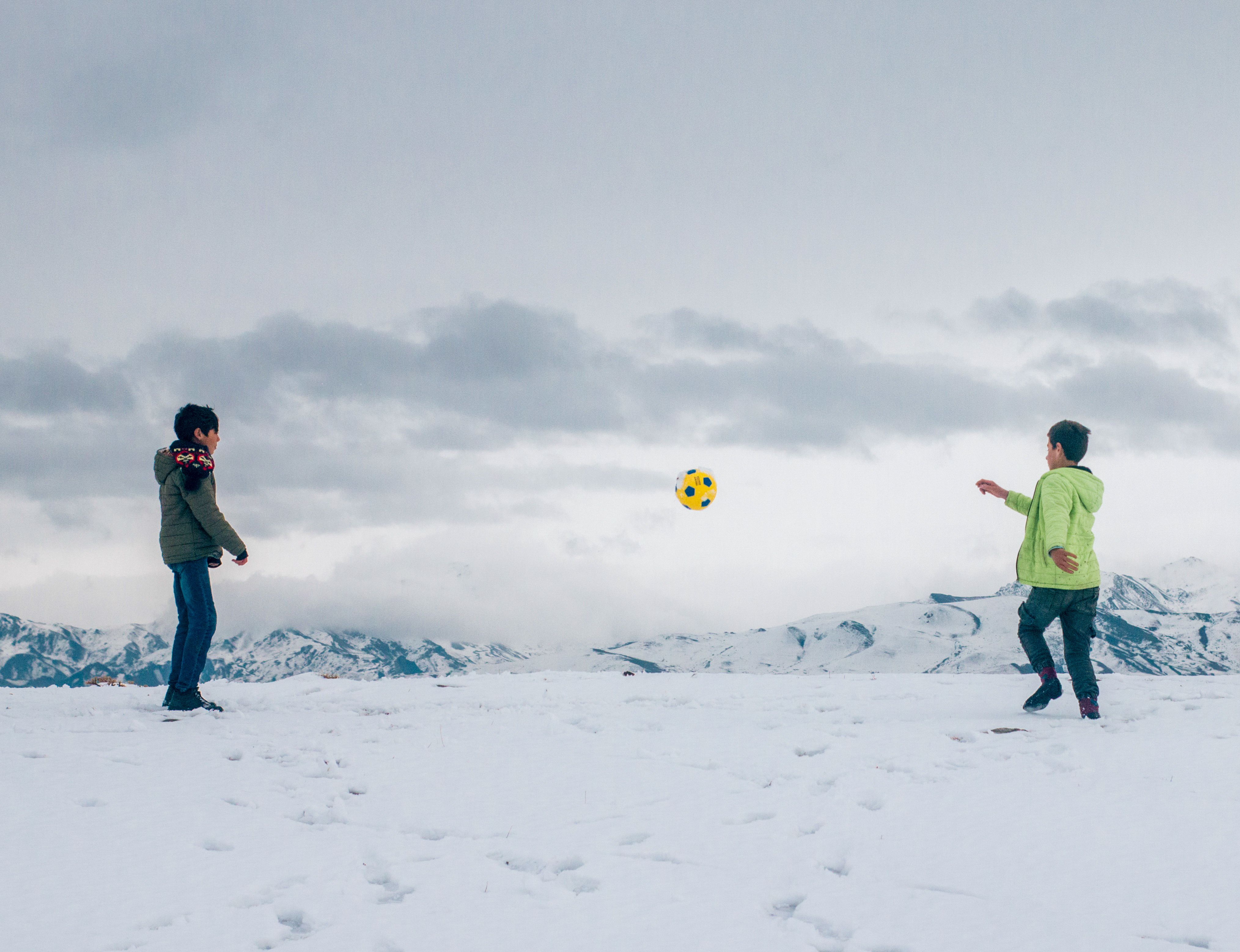 Children Playing Football in Snowy Landscape · Free Stock Photo