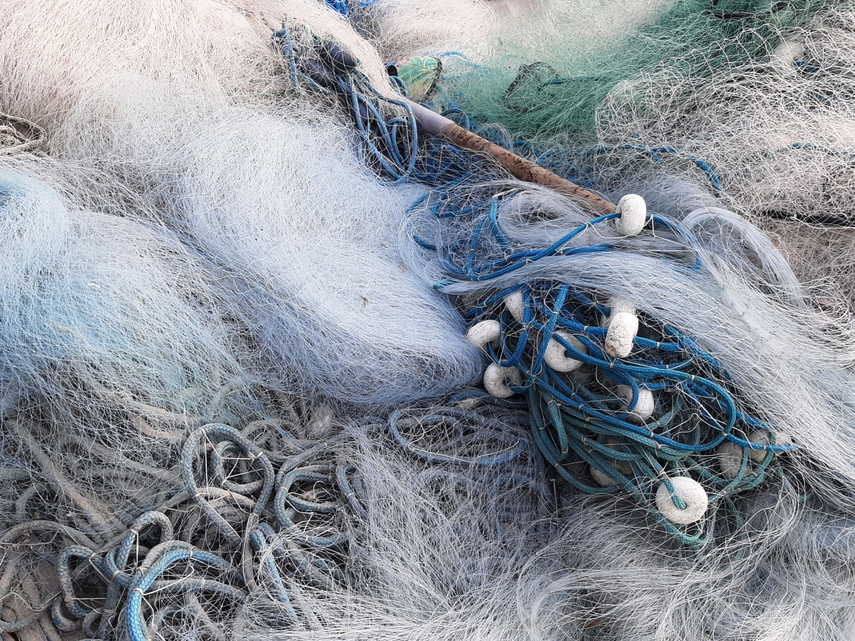 Detailed Closeup of Fishing Nets and Floats · Free Stock Photo