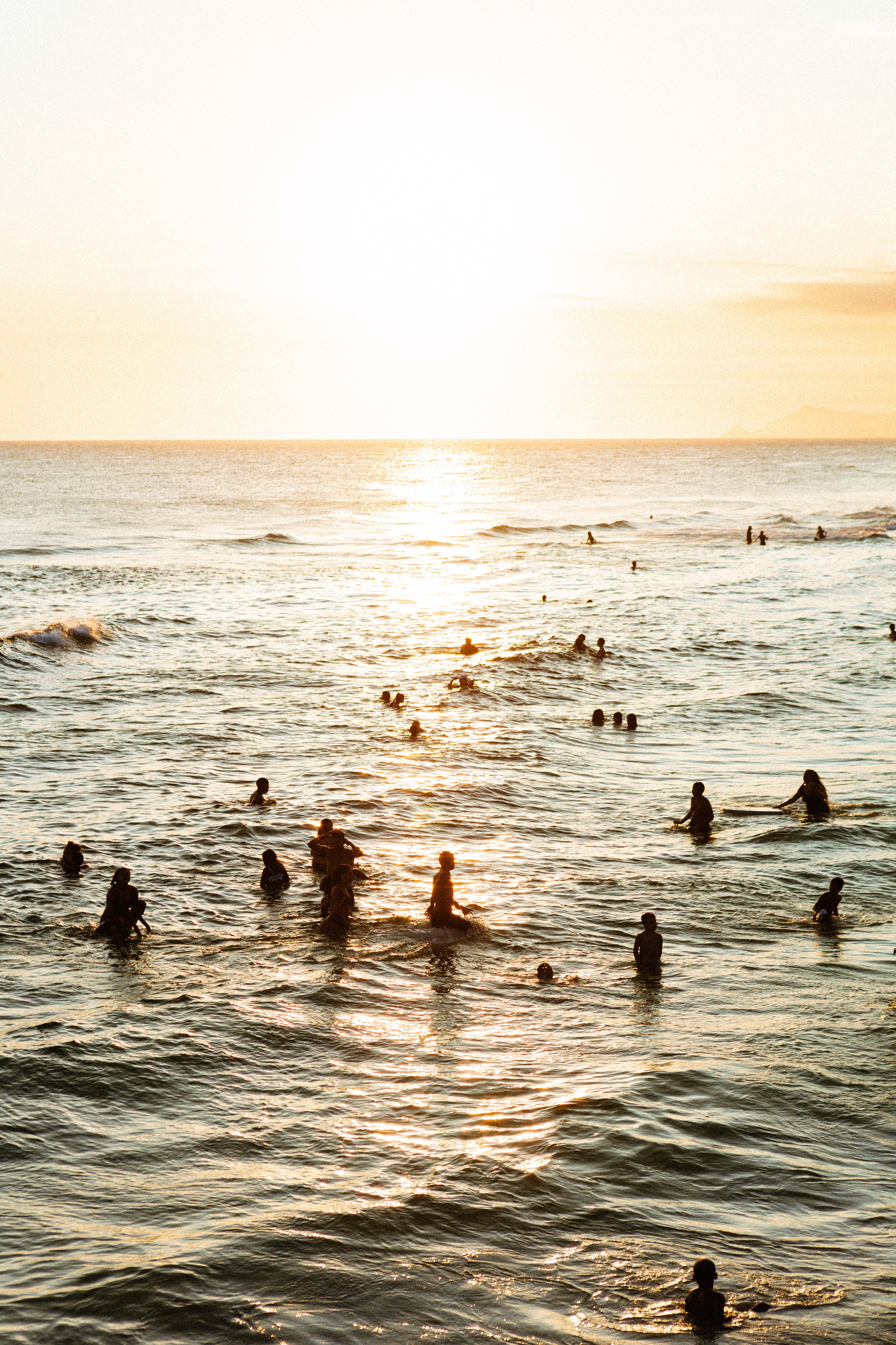 Serene Sunset Swim at Tropical Beach · Free Stock Photo