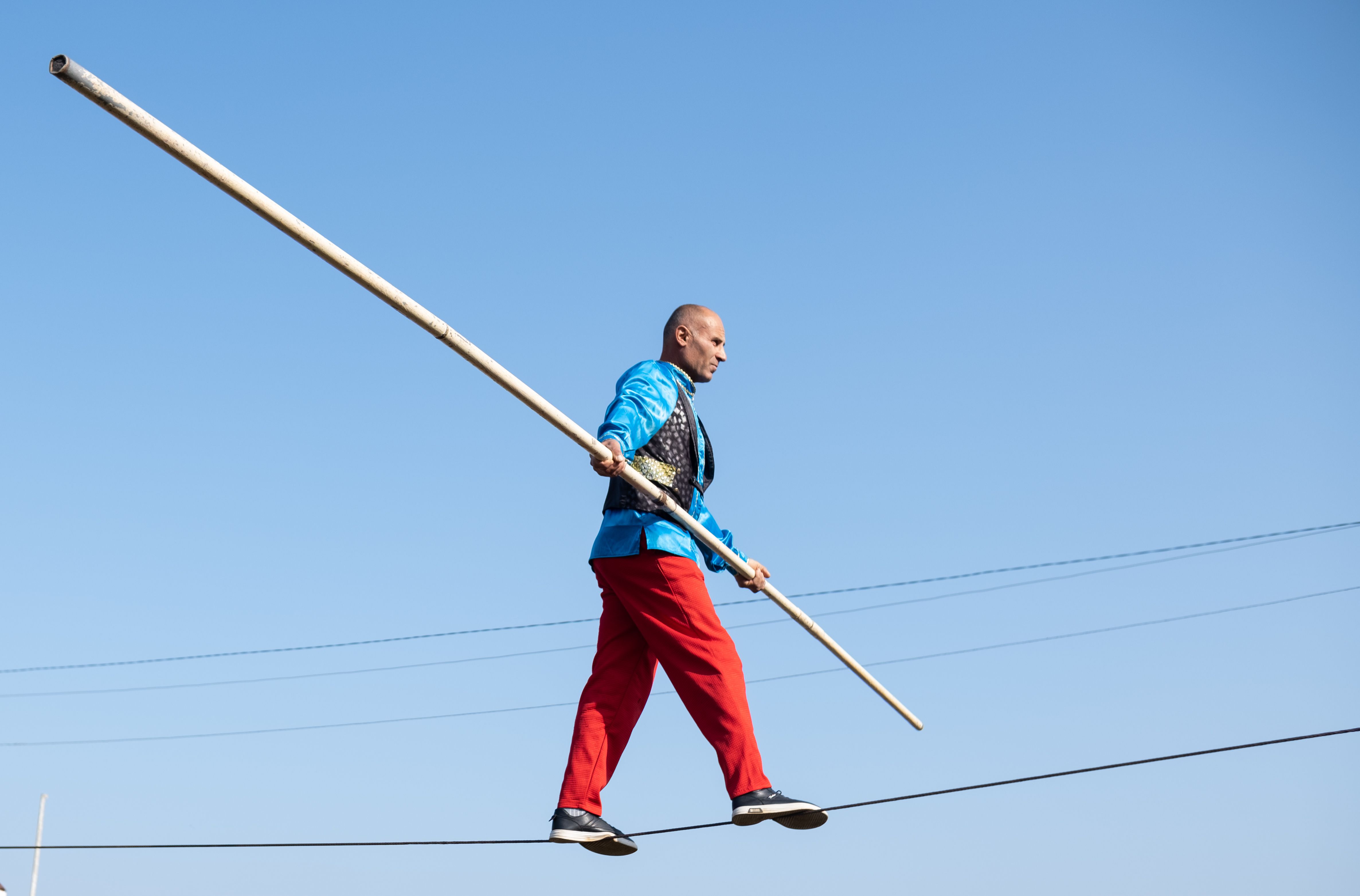 High Wire Artist Performing Balancing Act Outdoors · Free Stock Photo