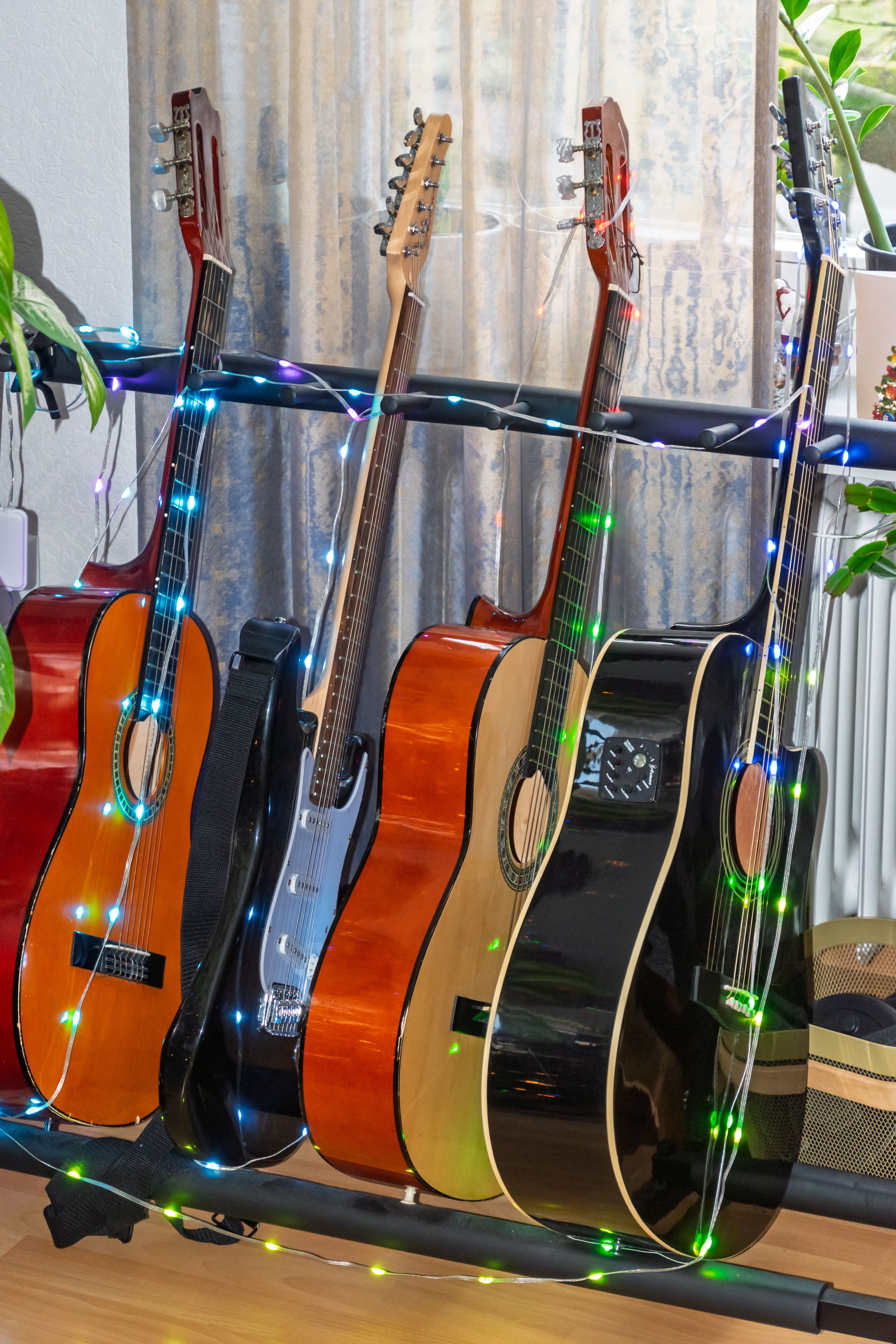 Colorful Guitars Decorated with Festive Lights · Free Stock Photo