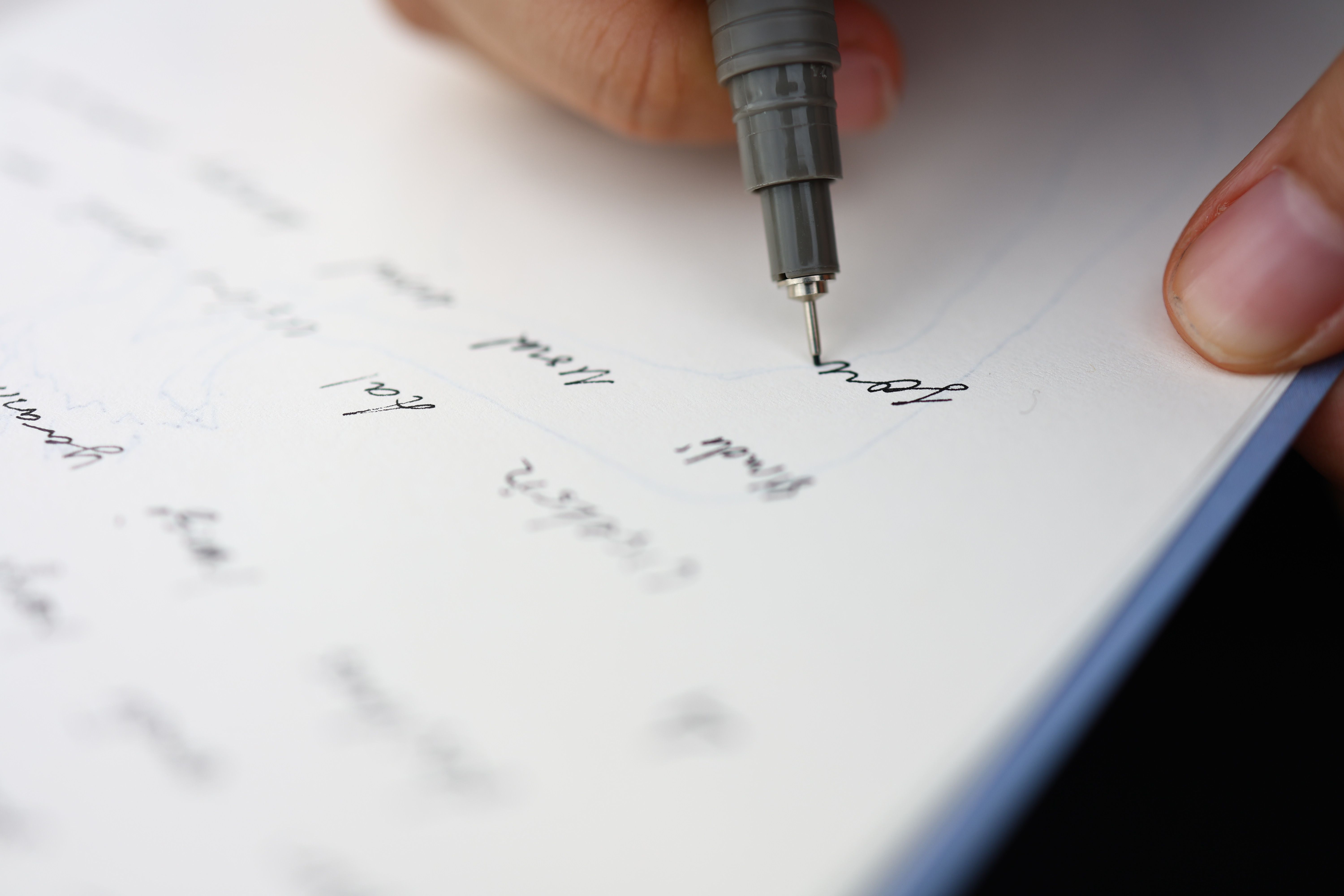 Close-up of Handwriting on Paper with Pen · Free Stock Photo