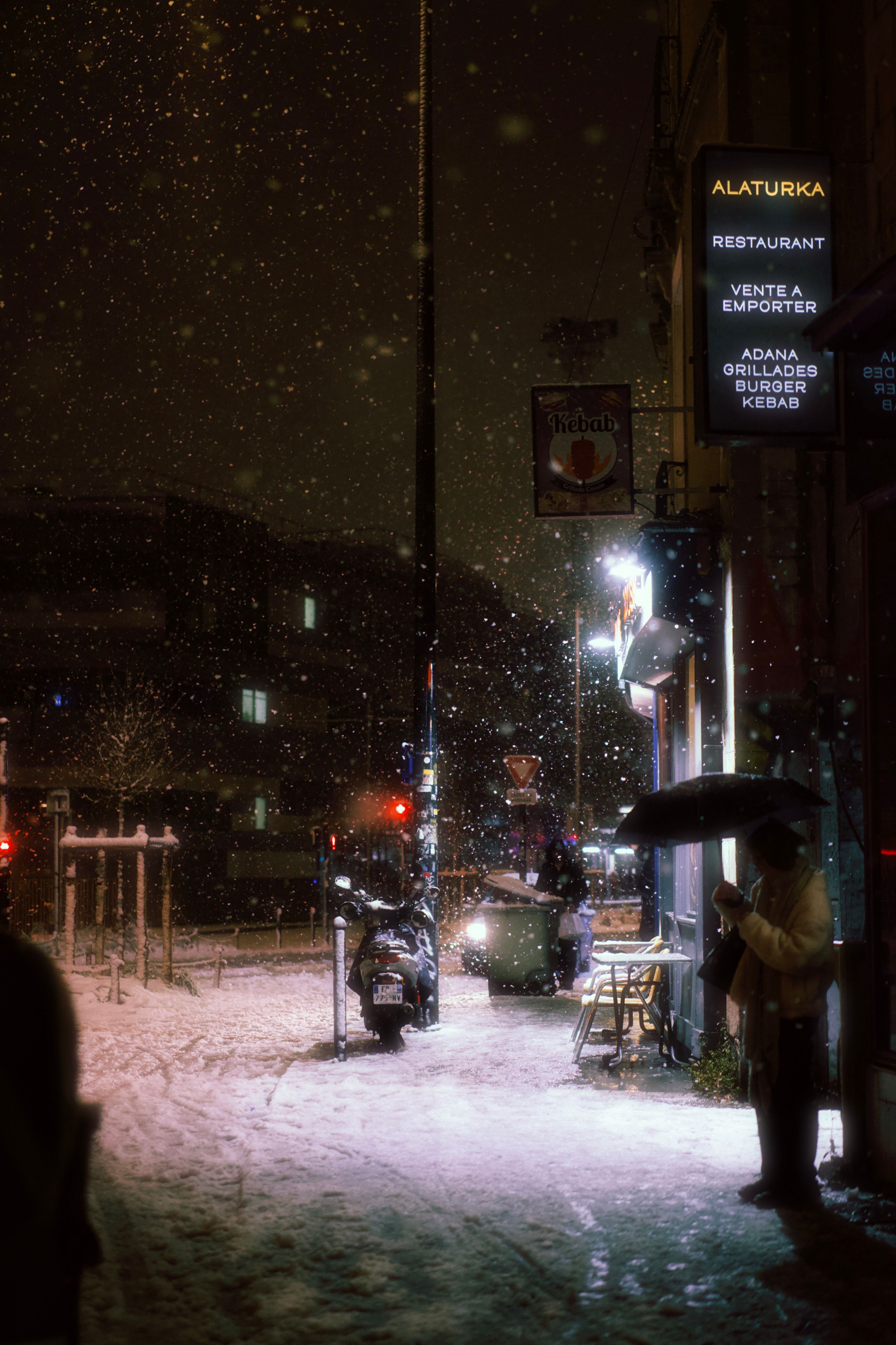 Snowy Night Scene Outside Restaurant with Lights · Free Stock Photo